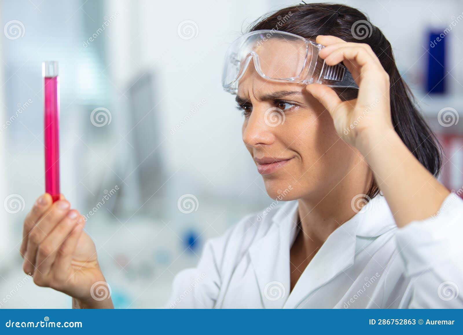 Bewildered Female Scientist Looking at Test-tube Stock Image - Image of ...