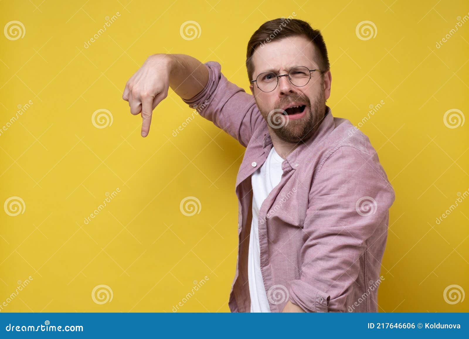 Bewildered Man Persistently Points Finger Down and Looks Inquiringly at ...