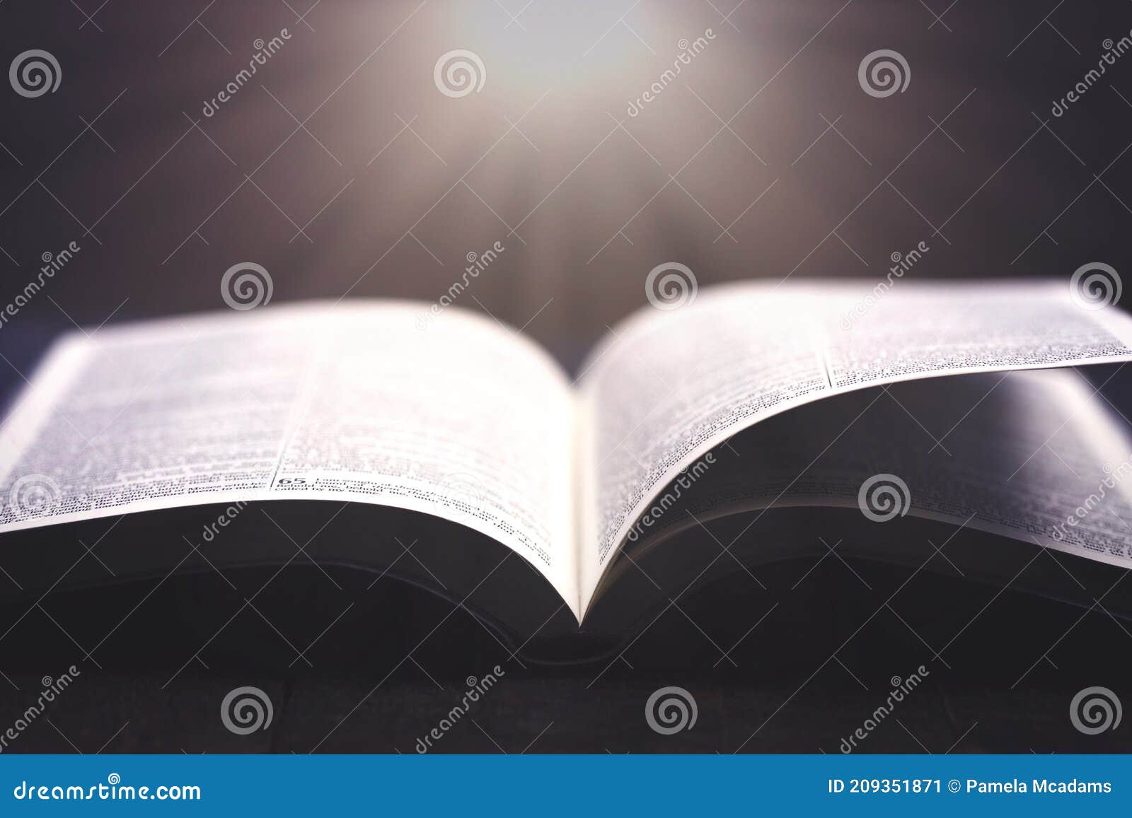 A Bible Open on a Rustic Wooden Table with Pages Blowing Open Stock ...