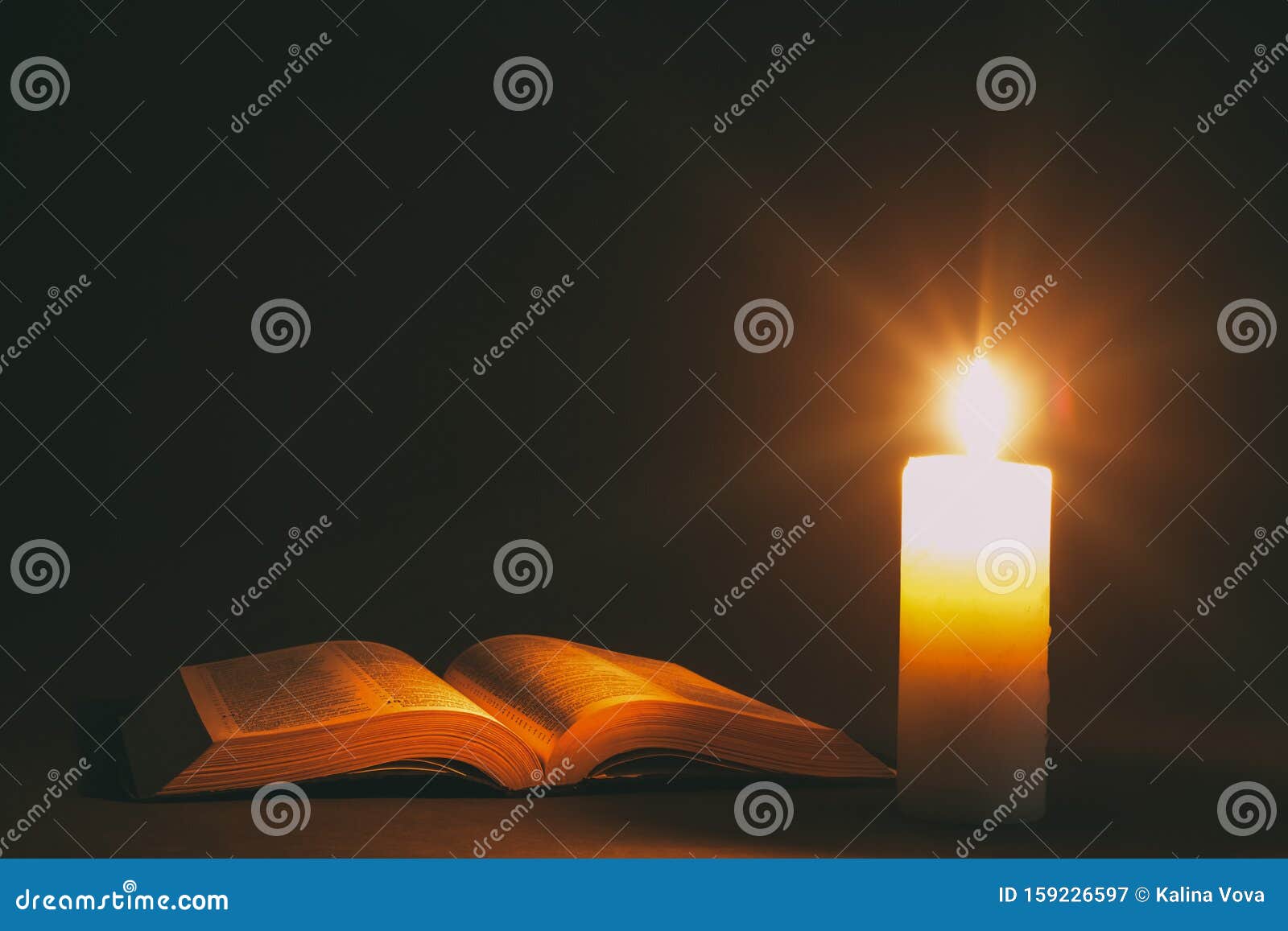 A Bible on the Table in the Light of a Candle Stock Image - Image of ...