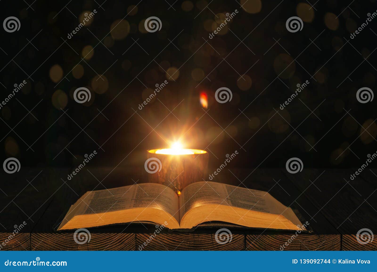 A Bible on the Table in the Light of a Candle Stock Photo - Image of ...