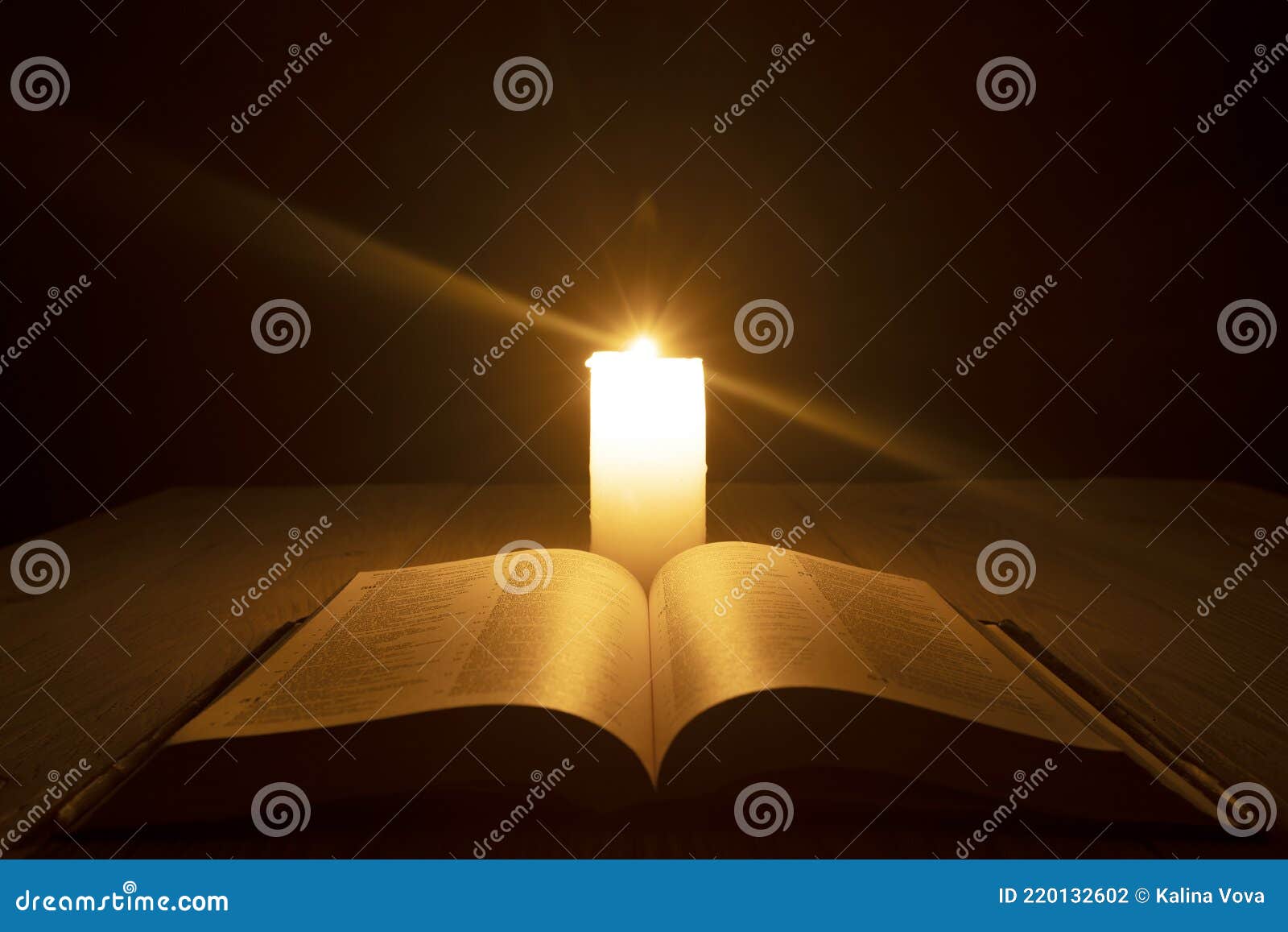 A Bible on the Table in the Light of a Candle Stock Photo - Image of ...