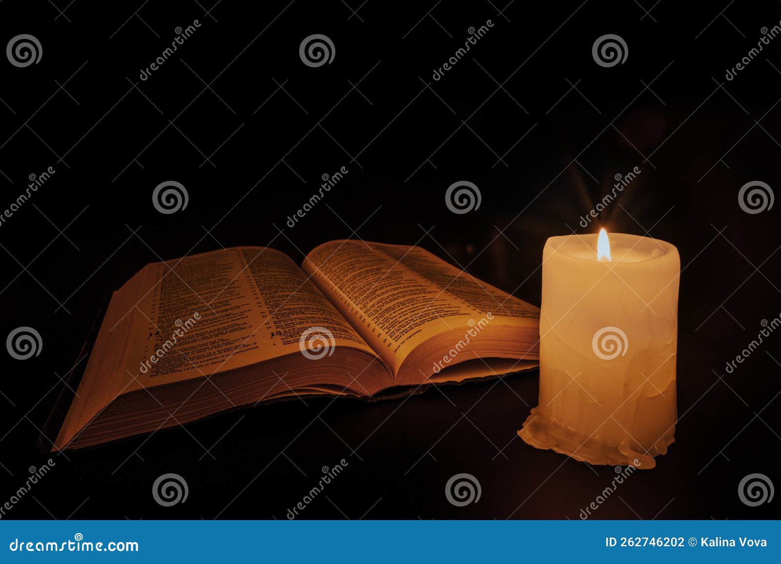 A Bible on the Table in the Light of a Candle Stock Photo - Image of ...