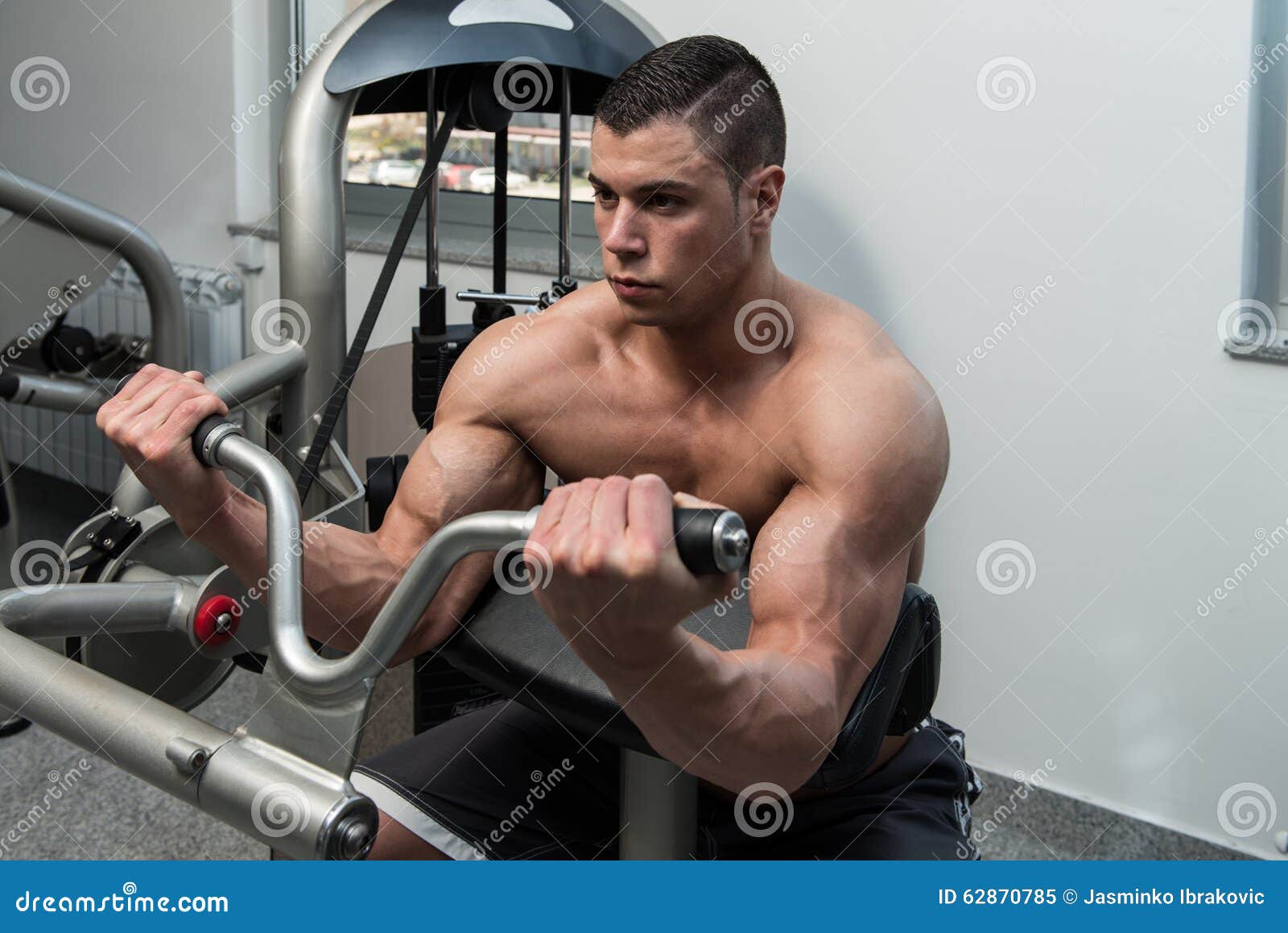 Biceps Workout on Machine stock image. Image of muscles - 62870785