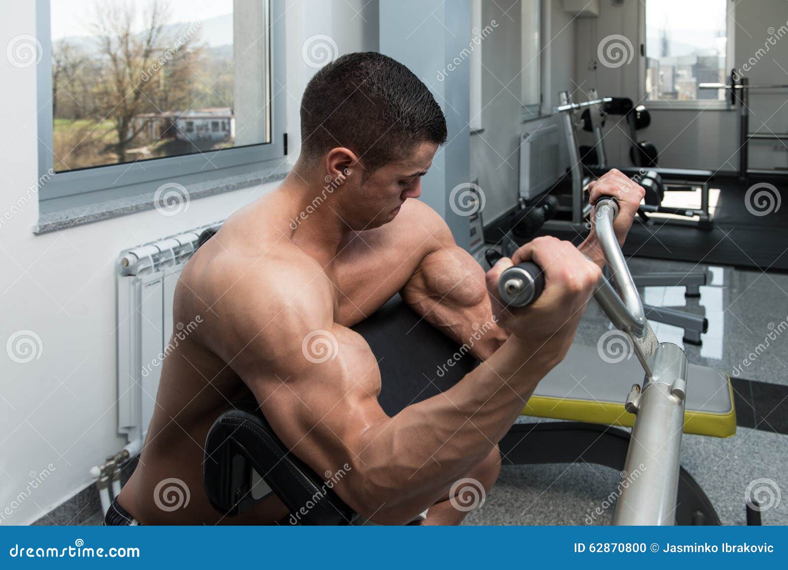 Biceps Workout on Machine stock photo. Image of building - 62870800