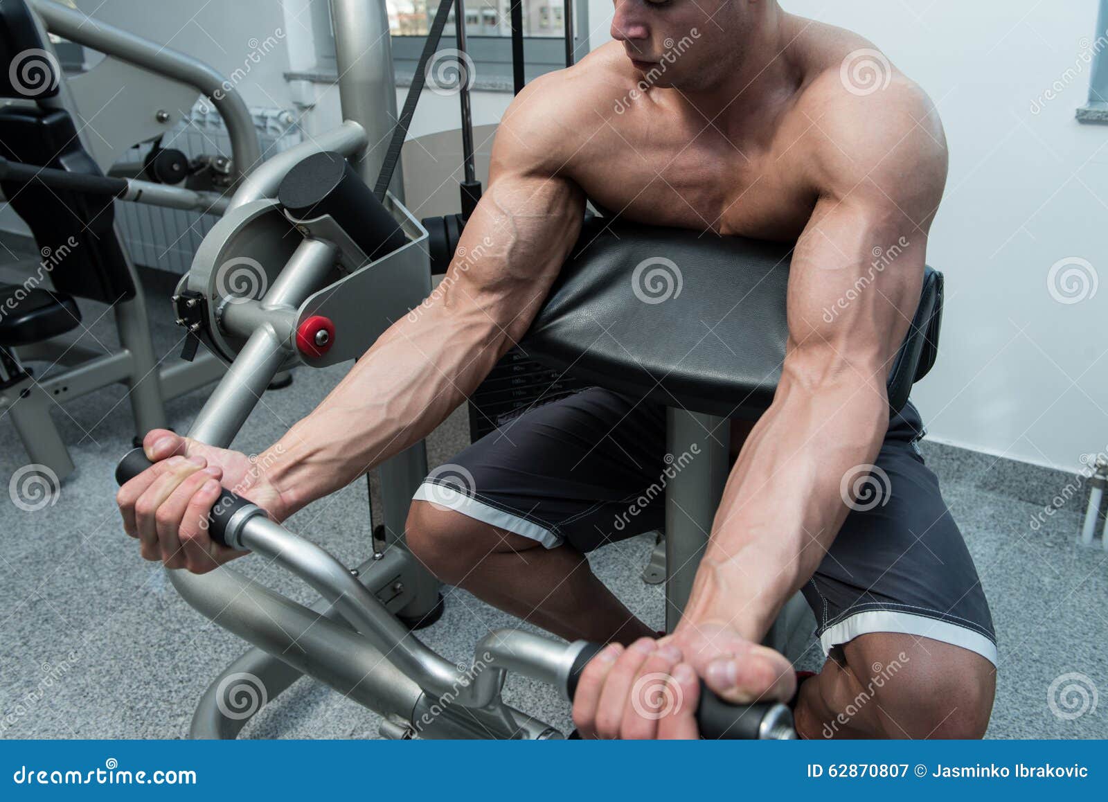 Biceps Workout on Machine stock image. Image of exercise - 62870807