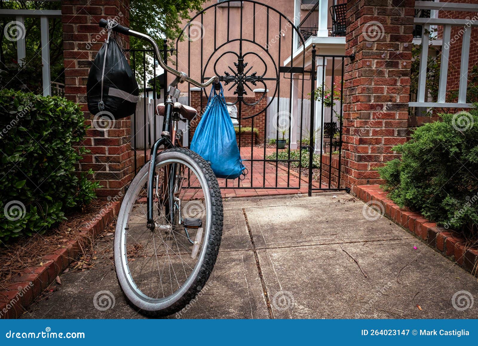 Bicycle with Blue Bag Parked Outside Gate Stock Image - Image of ...
