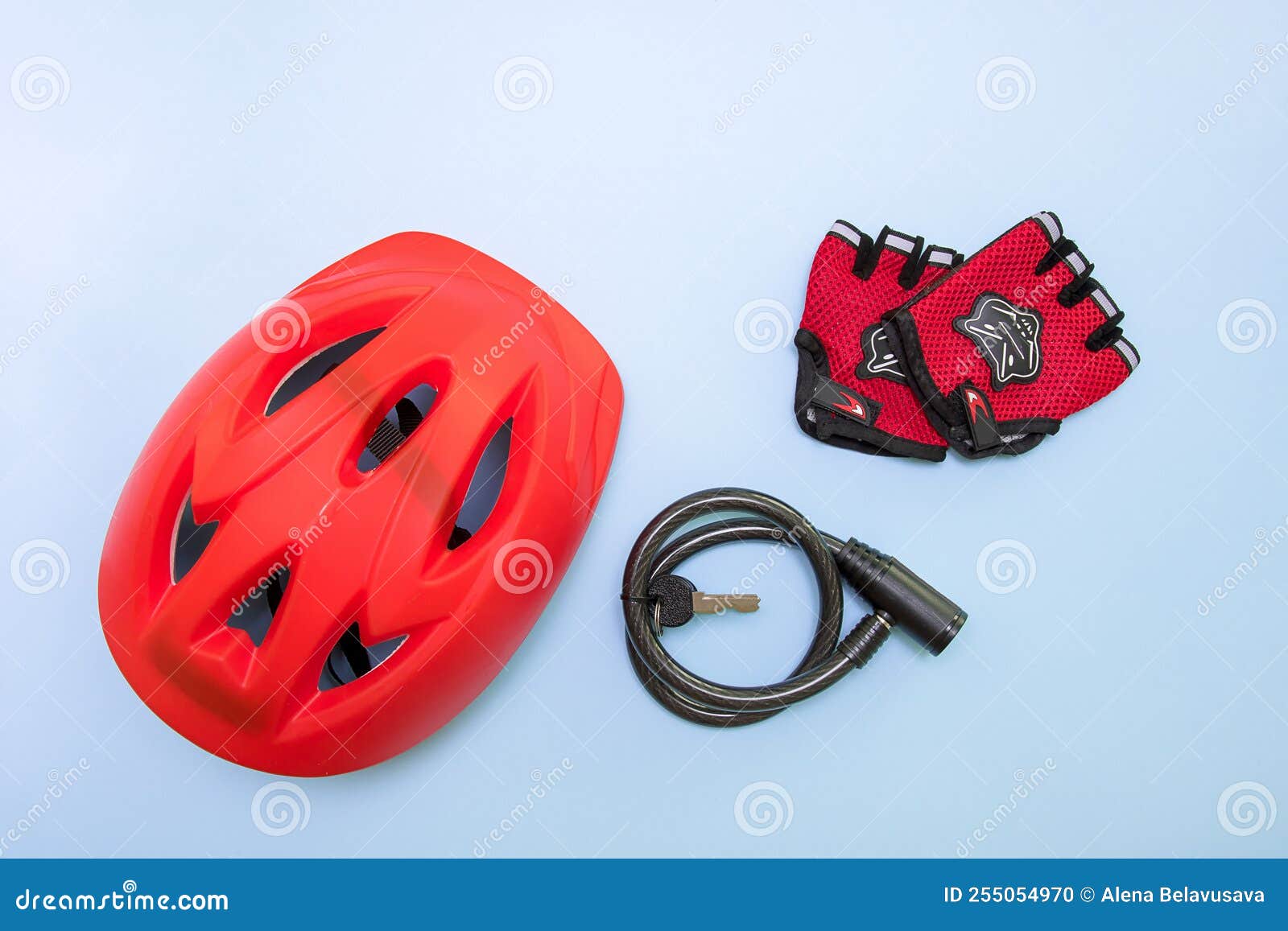 Bicycle Helmet, Lock with Keys and Gloves on a Blue Background Stock ...