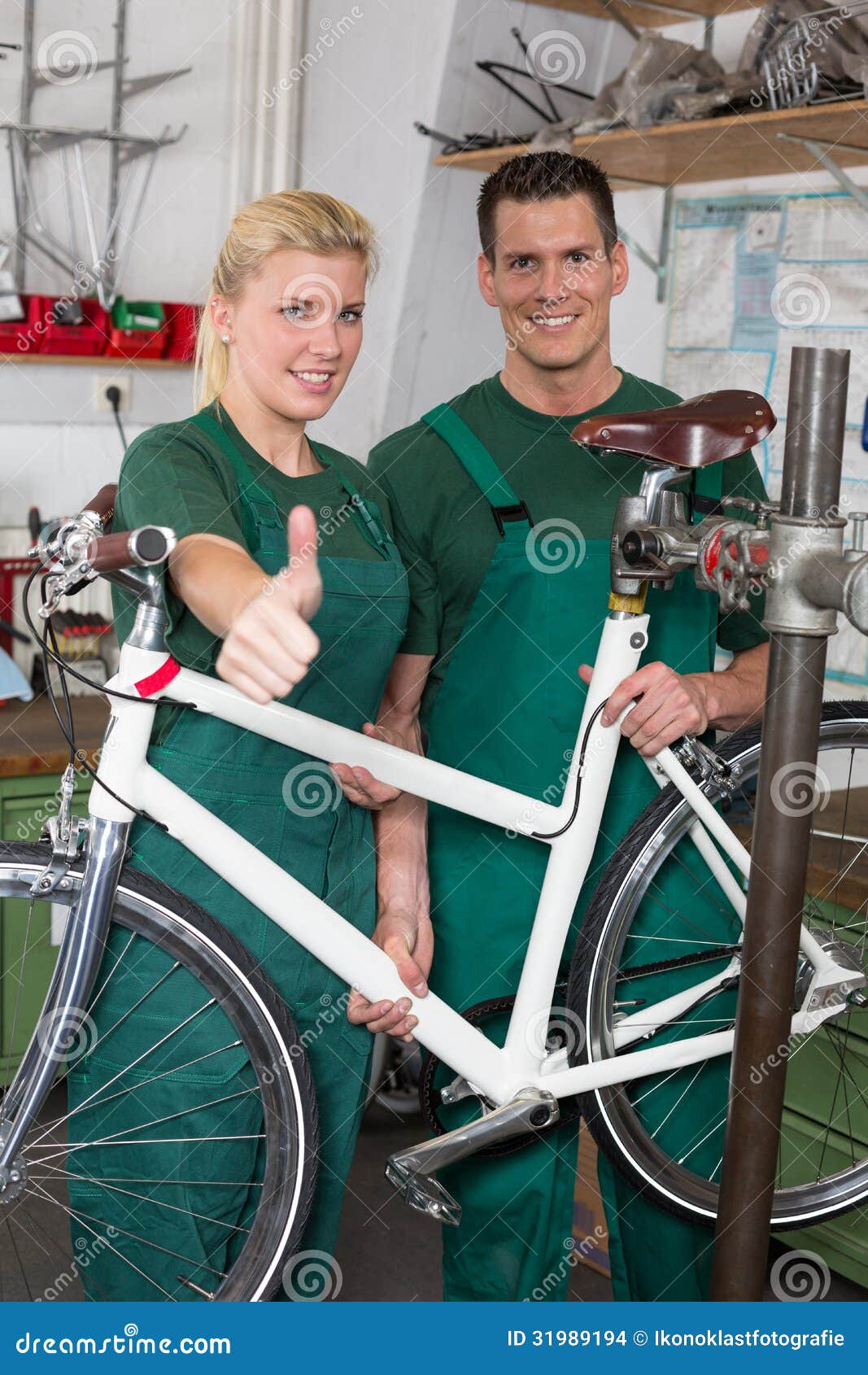 Bicycle Mechanic and Apprentice Repairing a Bike Stock Photo - Image of ...
