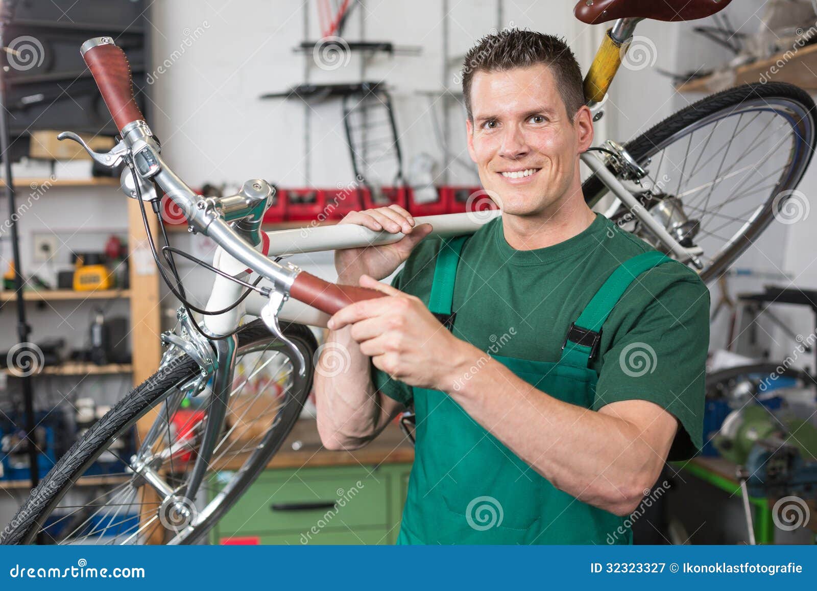Bicycle Mechanic Carrying a Bike in Workshop Smiling Stock Image ...