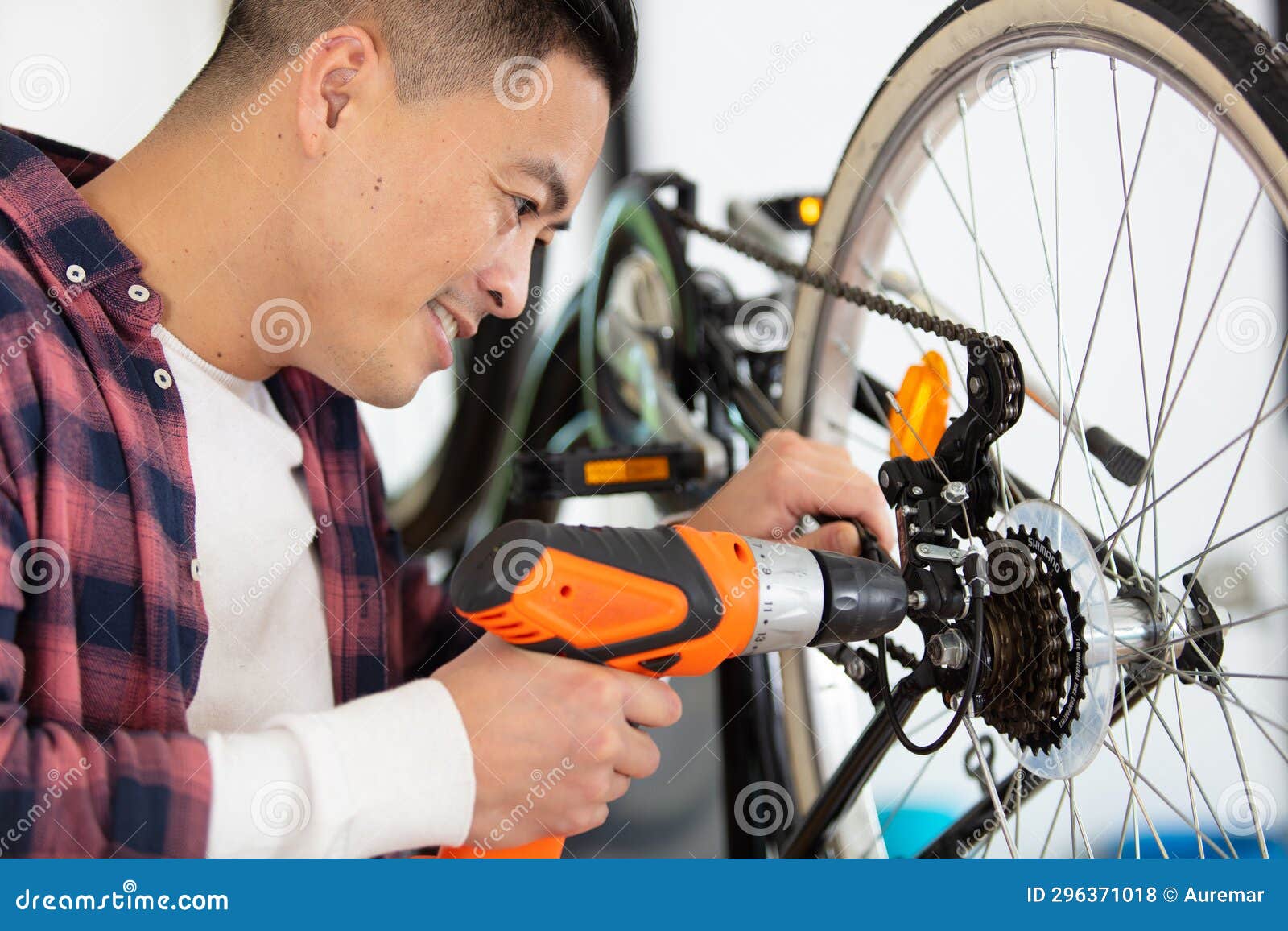 Bicycle Mechanic Working on Wheel with Cordless Screwdriver Stock Photo ...