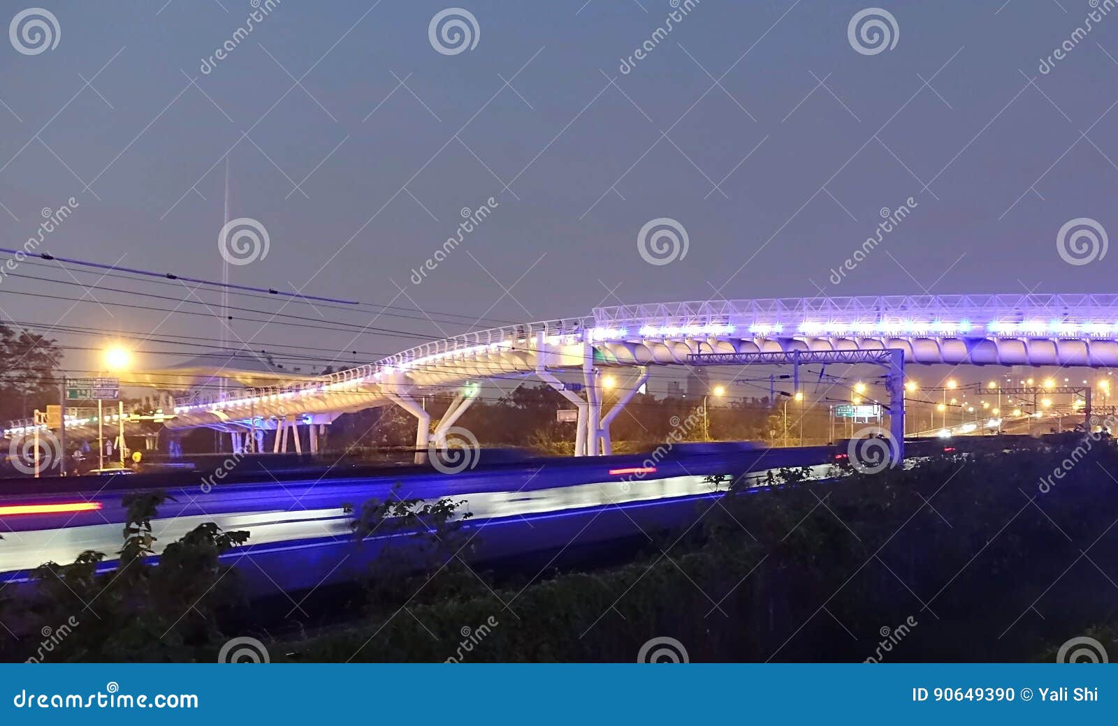 Bicycle Overpass and Passing Train at Night Stock Photo - Image of blur ...