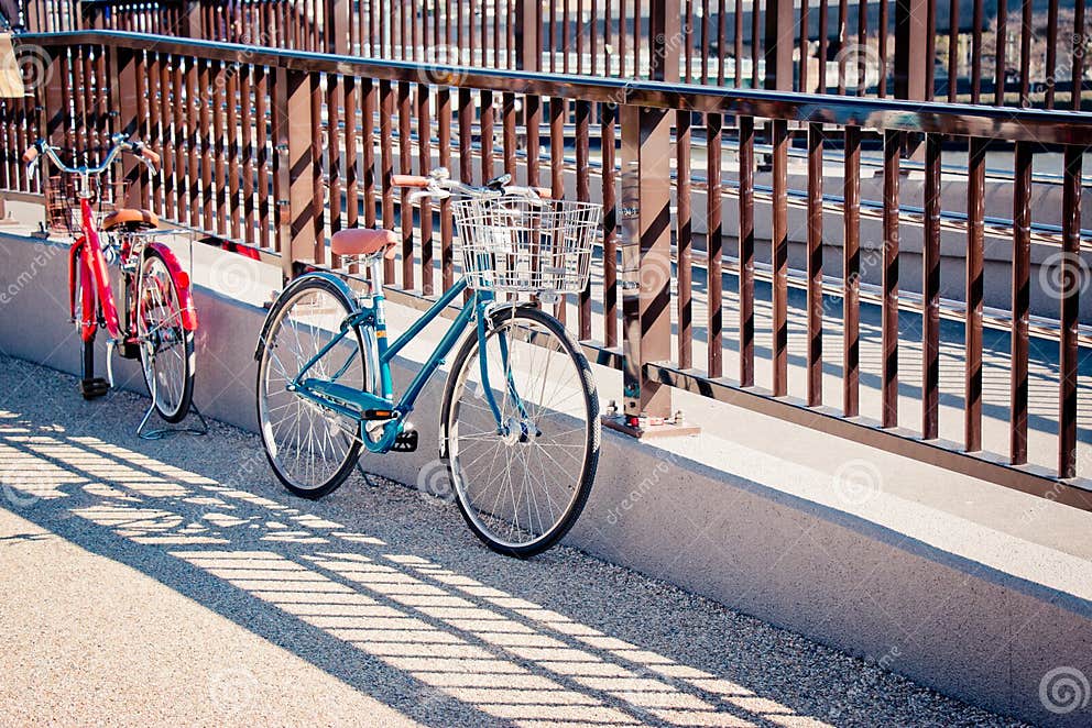 Bicycle Park at the Railing on the Road Stock Image - Image of cross ...