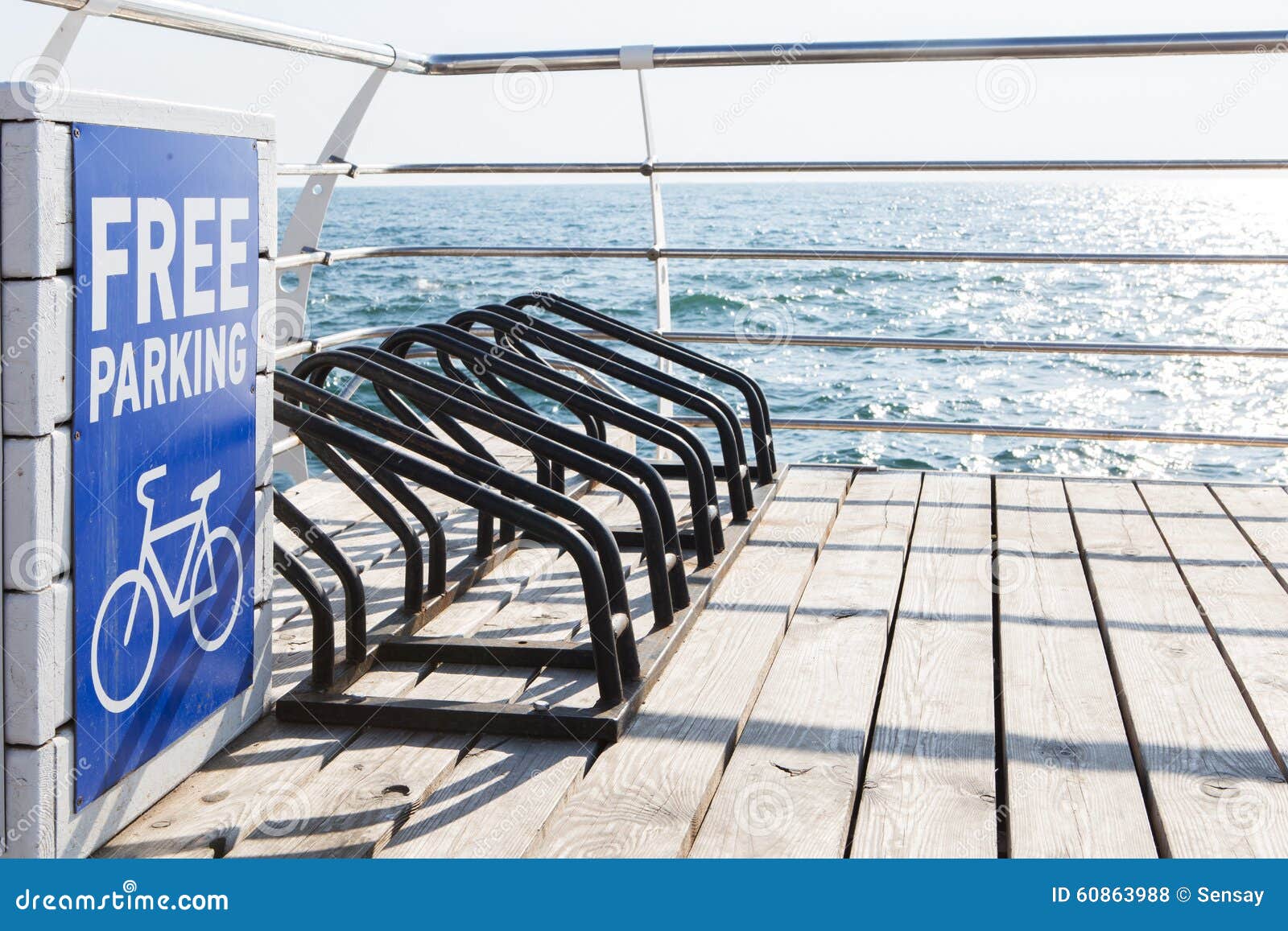 Bicycle Parking on Wooden Seafront, Sea on Background Stock Photo ...