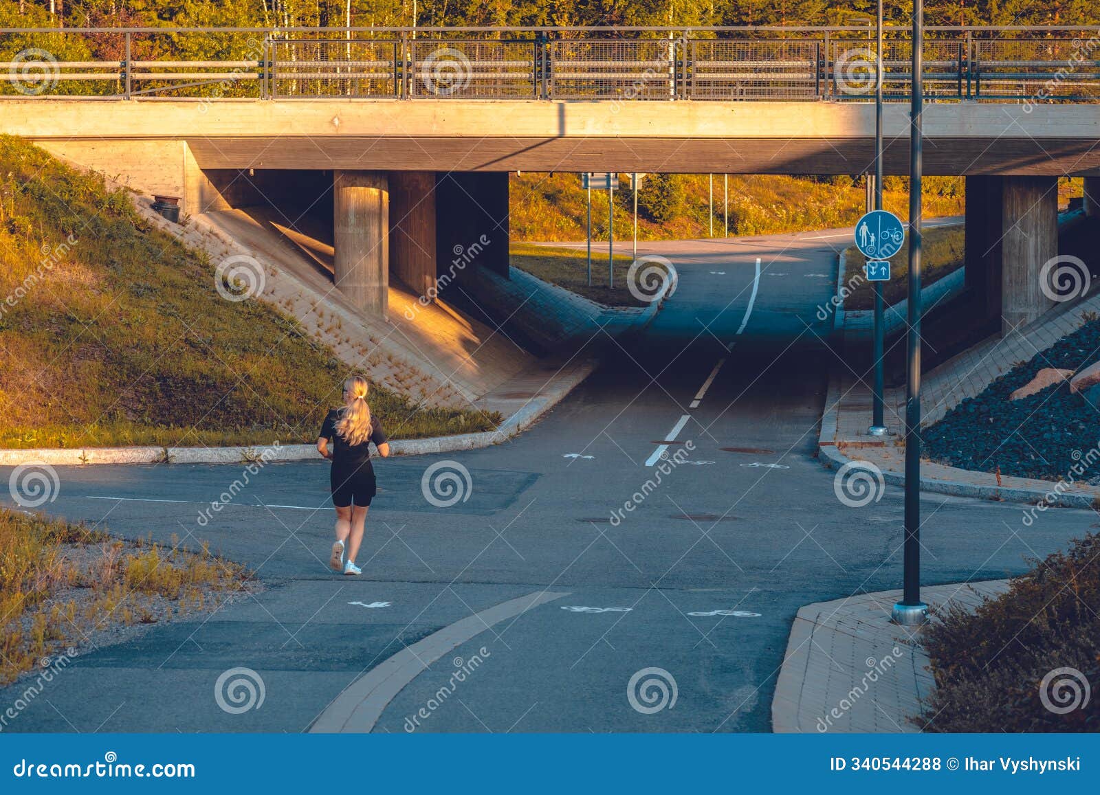 Bicycle and Pedestrian Paths Under the Bridge with a Running Man Stock ...
