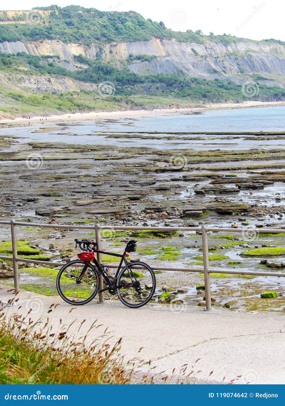 Bicycle at Rest on Railing by Ocean and Mountian Backdrop Stock Photo ...
