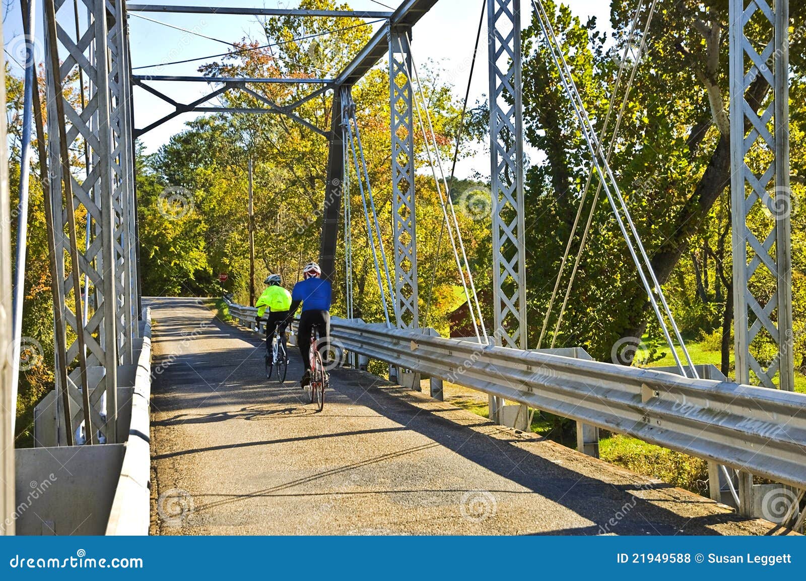 Bicycle Riders on a Bridge stock photo. Image of place - 21949588