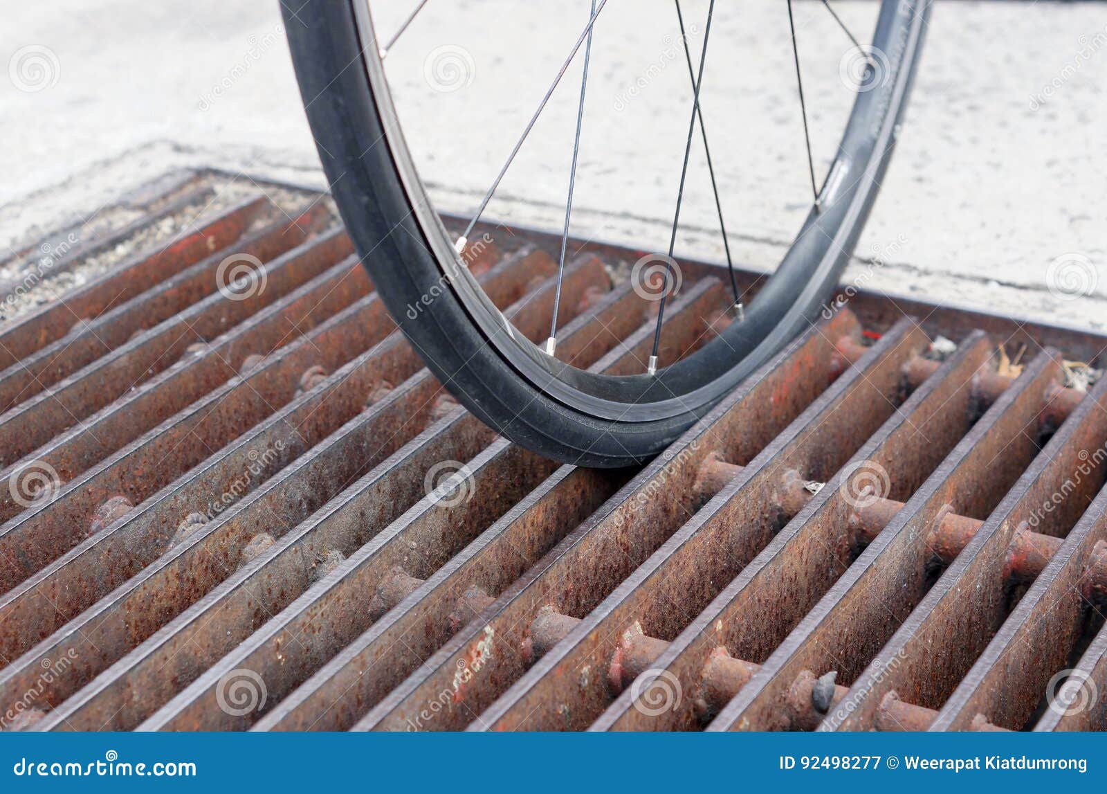 Bicycle Wheel Stuck in the Drain Lid Stock Image - Image of safety ...