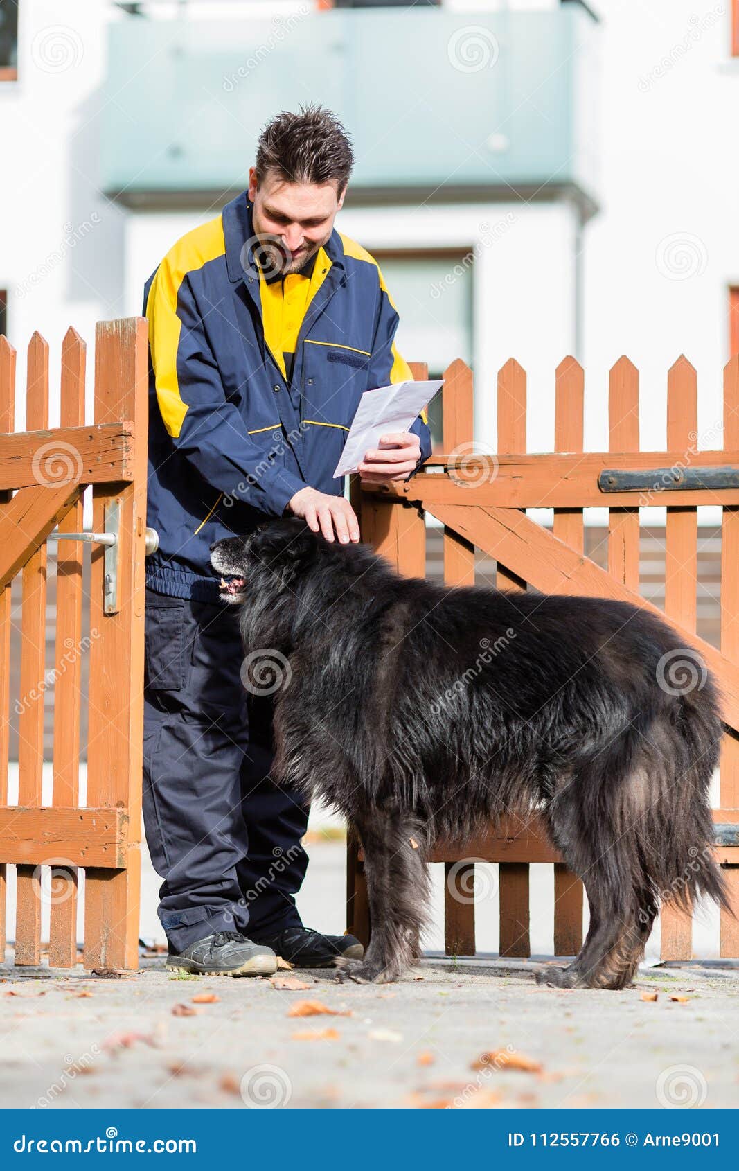 Big Black Dog Welcoming Postman at Garden Gate Stock Photo - Image of ...