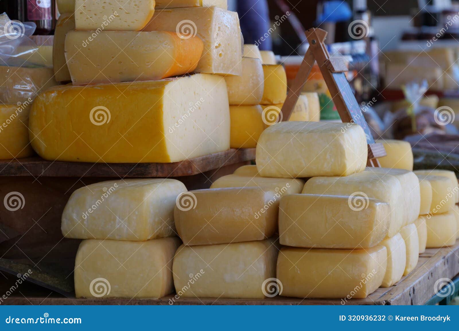 Big Blocks of Cheese Stacked on a Table in a Market Stock Photo - Image ...