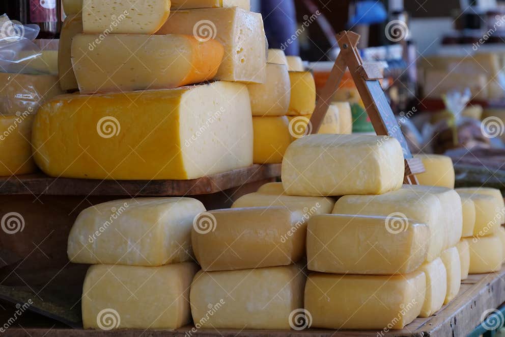 Big Blocks of Cheese Stacked on a Table in a Market Stock Photo - Image ...