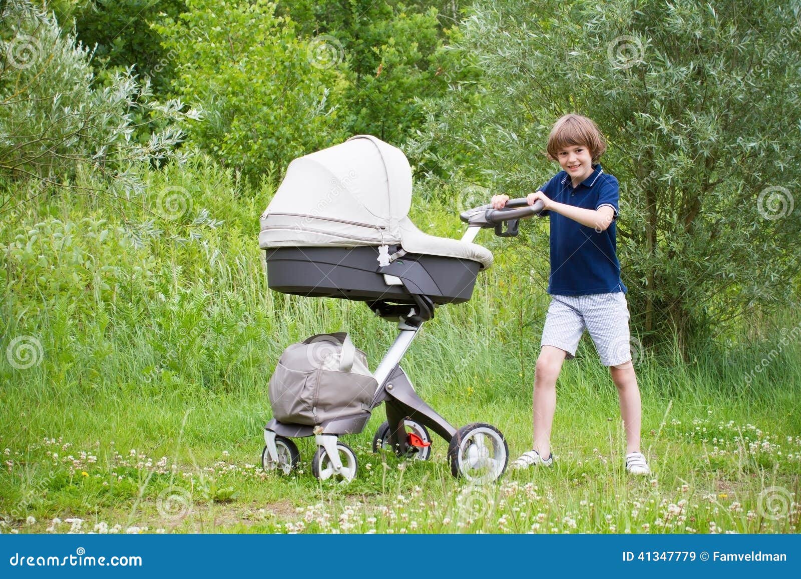 Big Brother Pushing a Stroller in the Park Stock Image - Image of ...