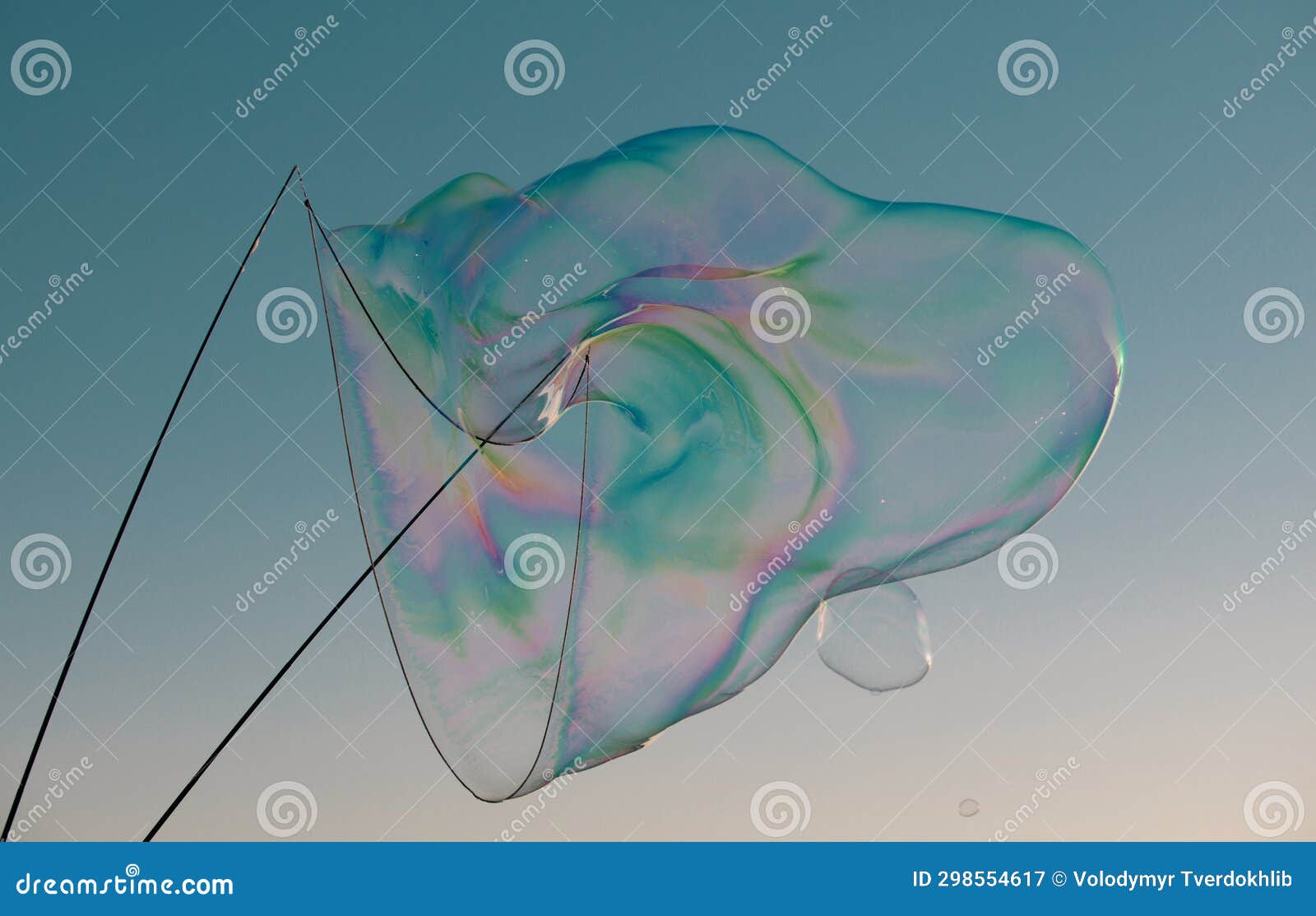 Big Bubble Flying Over Blue Sky. Huge Colorful Soap Bubbles Fly Over ...