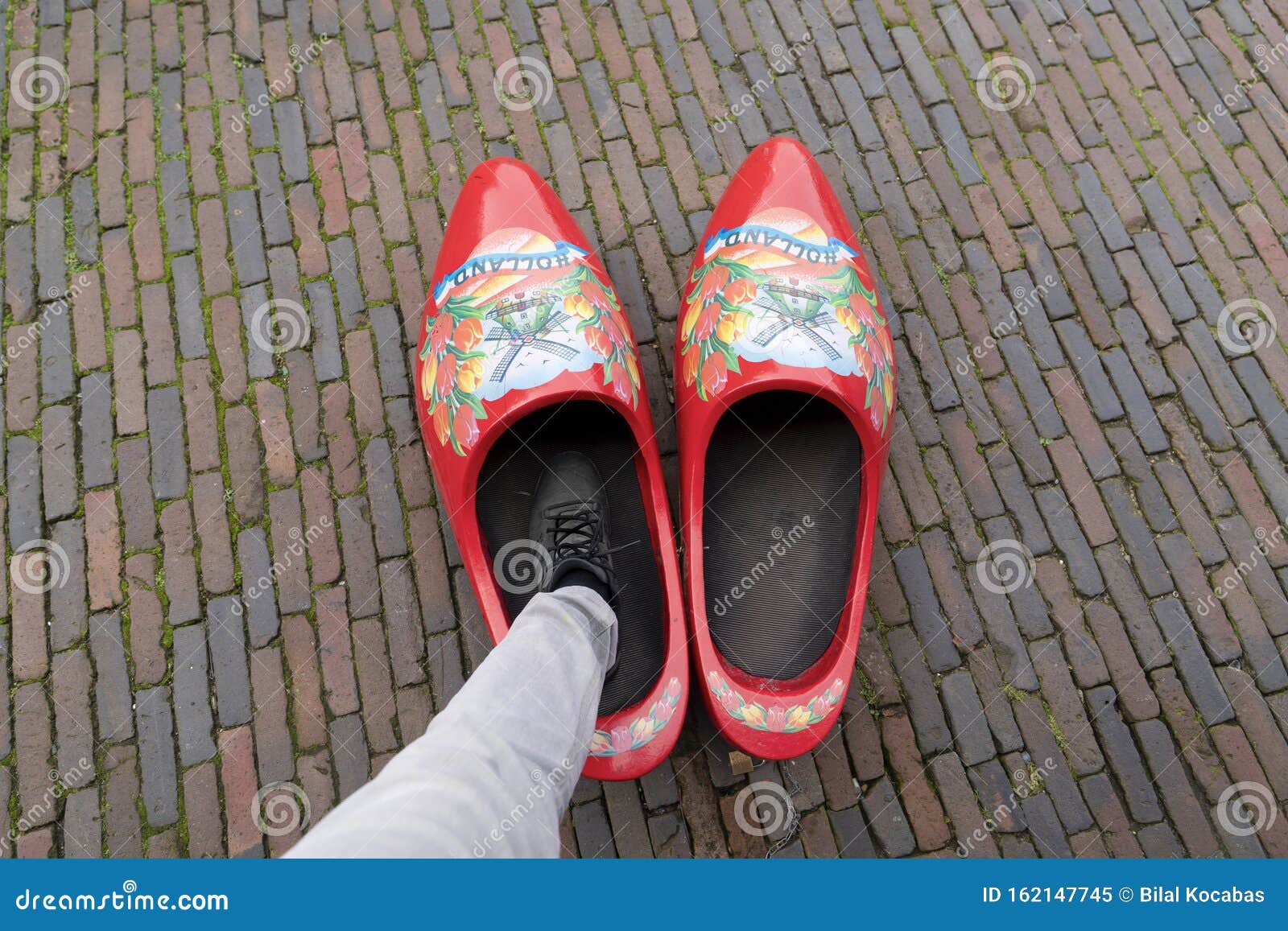 Big Clogs with Man`s Leg in Holland. Man Try Big Clogs in Nederland ...