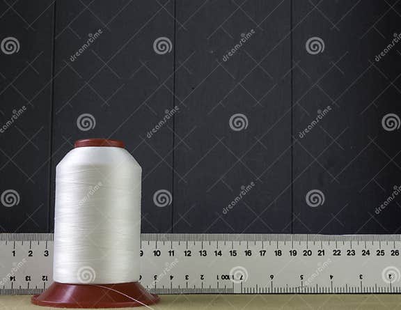 Big Cone of White Thread with a Sewing Ruler Behind it. Stock Photo ...