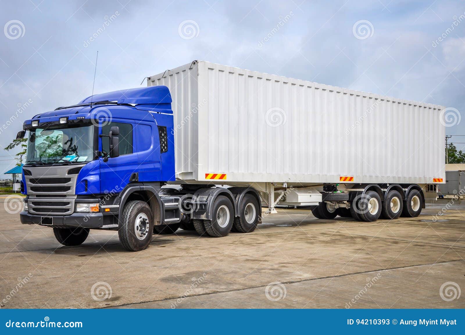 Photo of Big Tractor, with Container Trailer, To Deliver Goods and ...