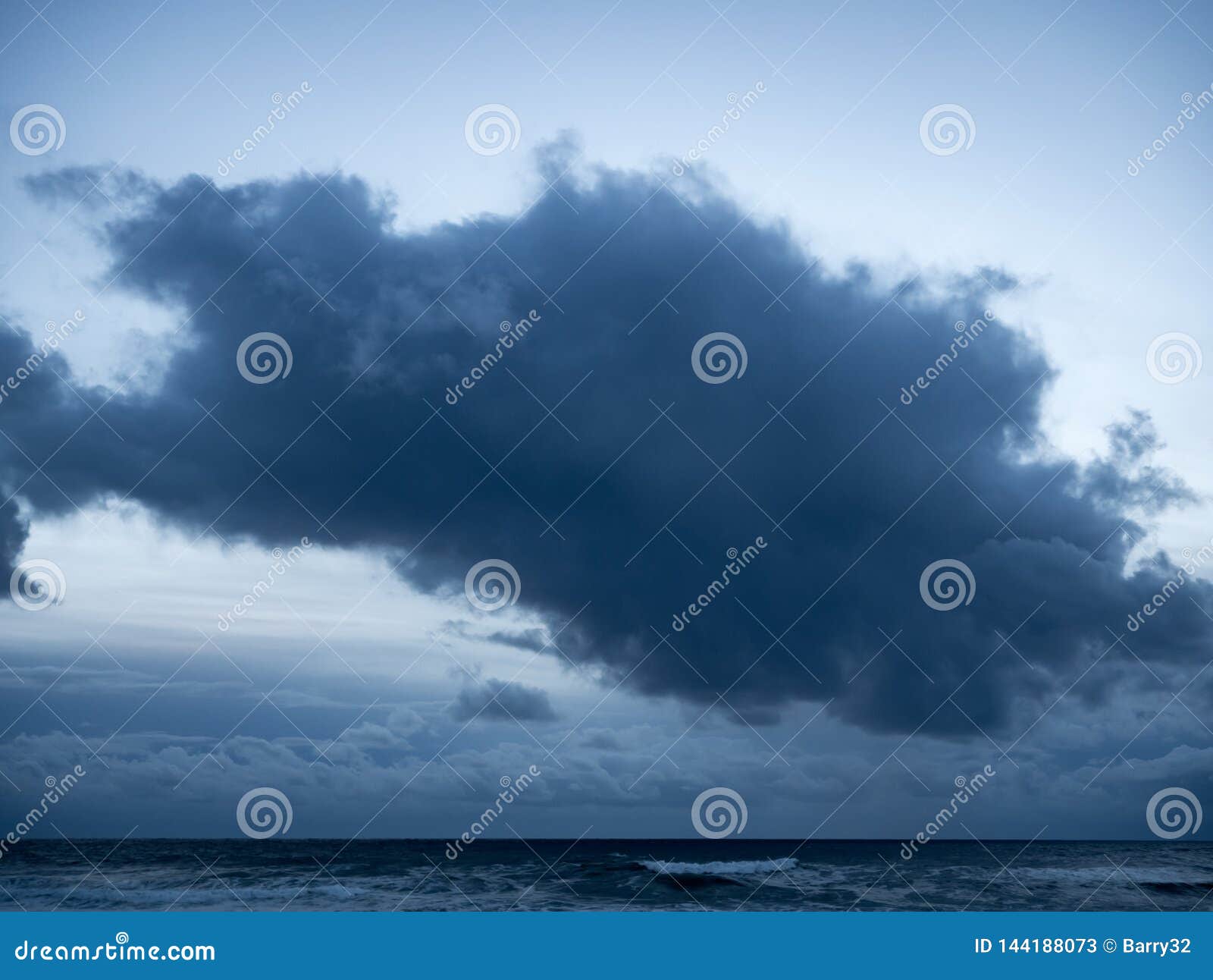 Big, Dark, Foreboding Storm Cloud Over Ocean at Dusk. Stock Image ...