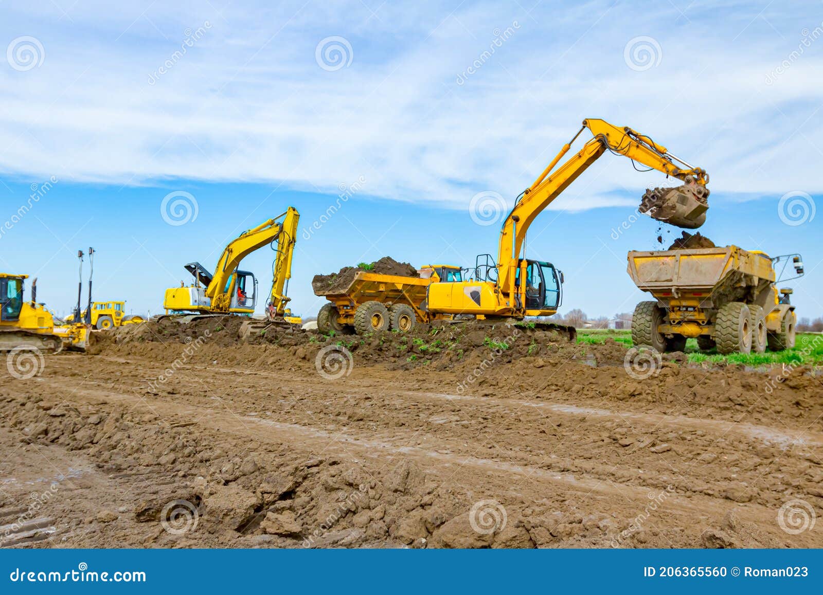 Big Excavators are Loading Two Trucks with Ground on Building Site ...