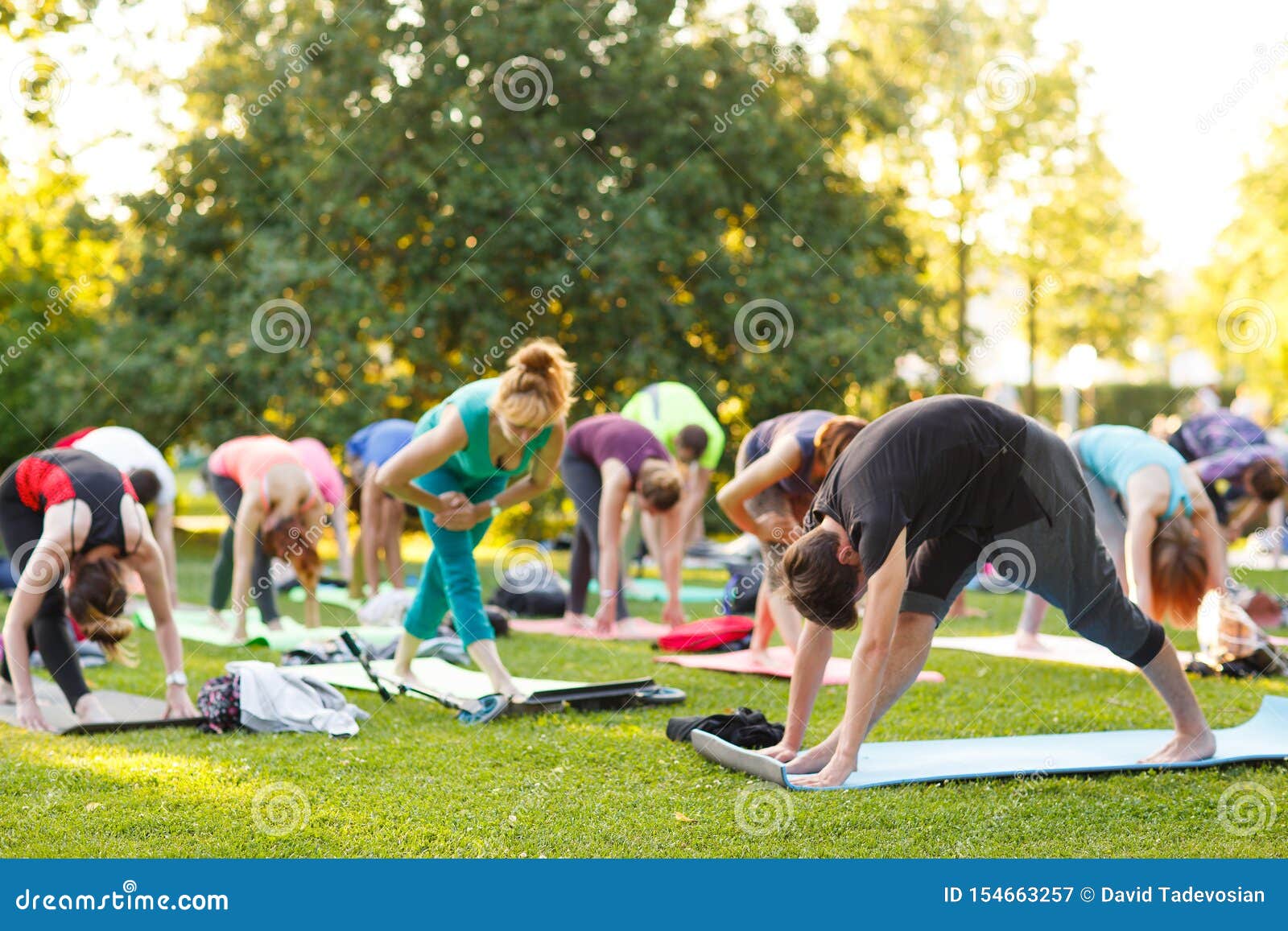 Big Group of Adults Attending a Yoga Class Outside in Park Stock Image ...