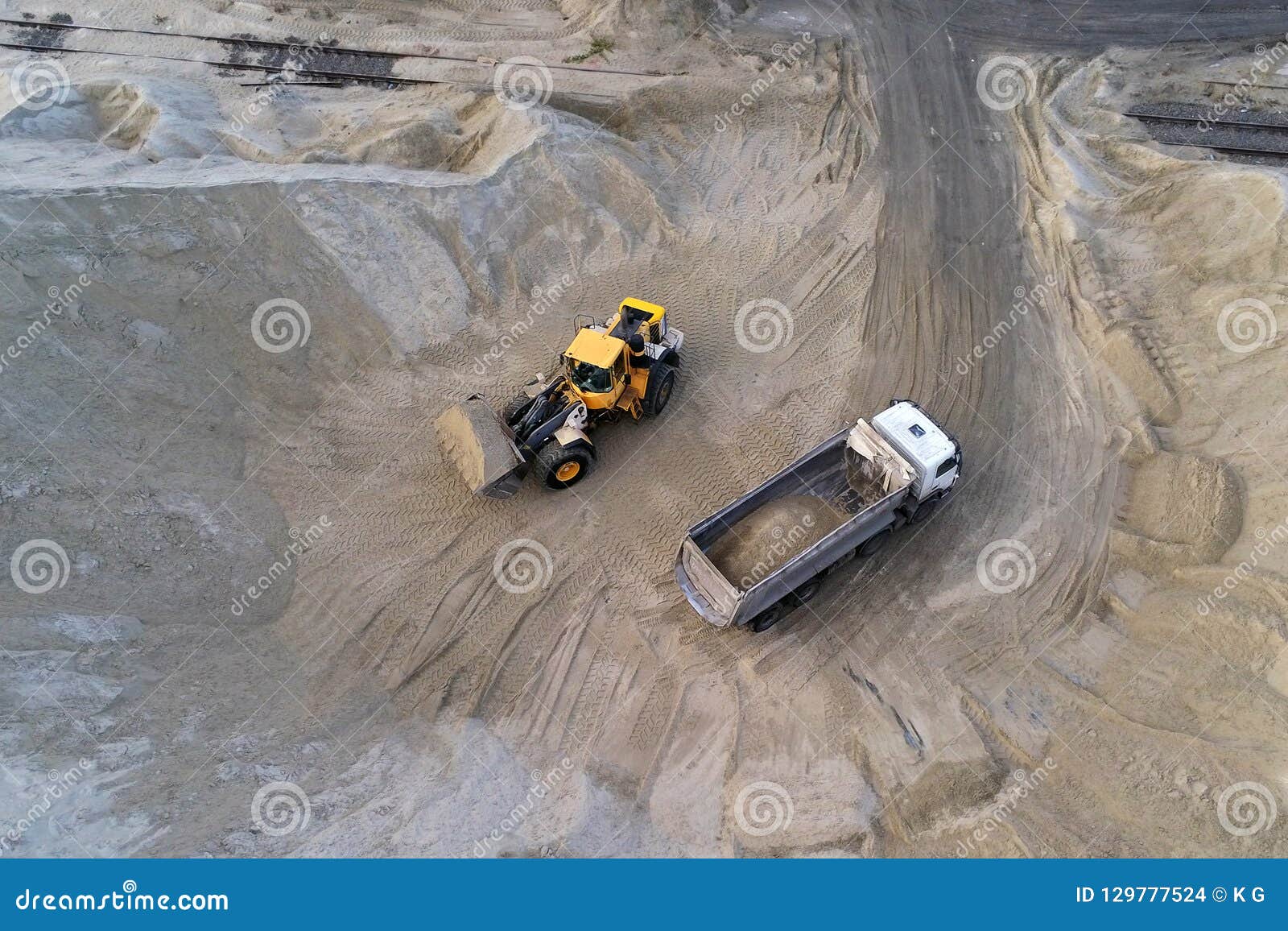 Big Heavy Wheel Loader Loading Sand into Dump Truck in Sand Pit. Heavy ...