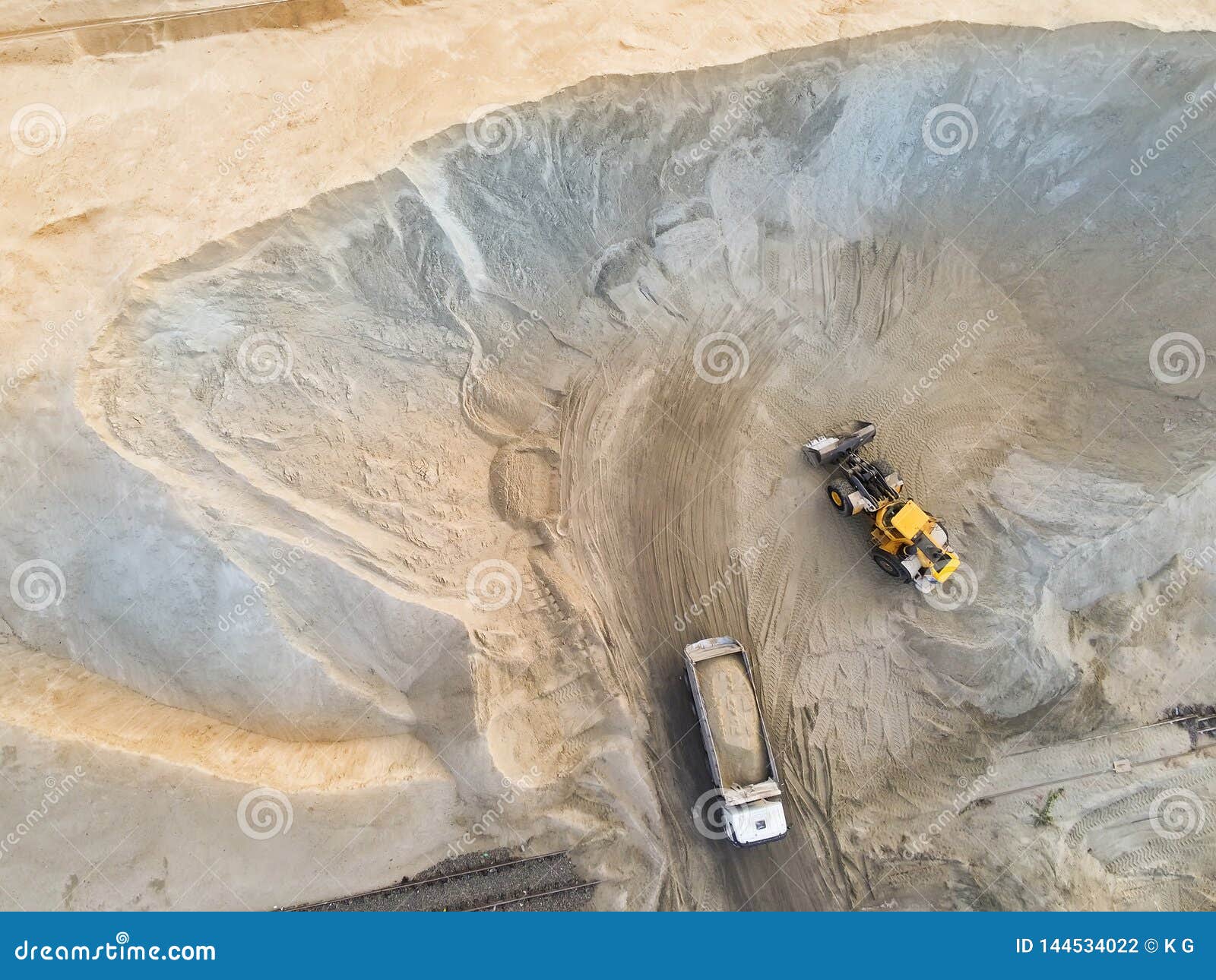 Big Heavy Wheel Loader Loading Sand into Dump Truck in Sand Pit. Heavy ...