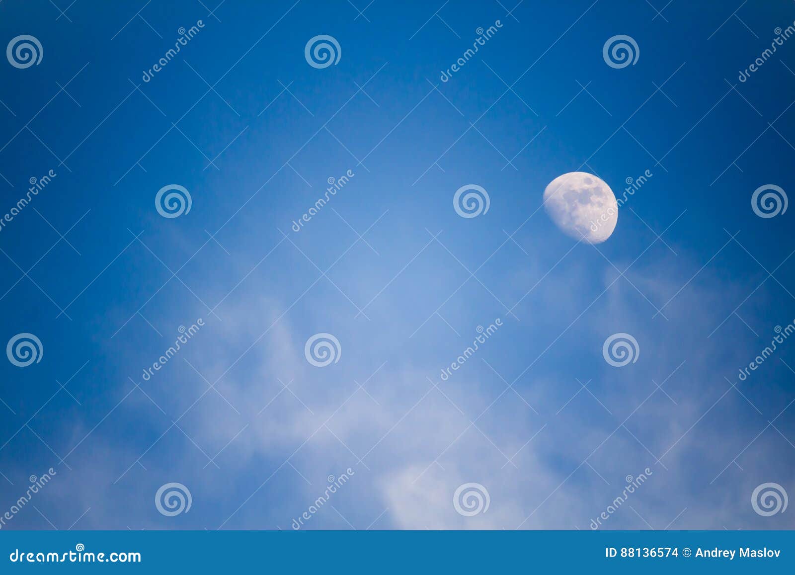 A Big Moon in the Afternoon Against a Blue Sky with Clouds Stock Photo ...