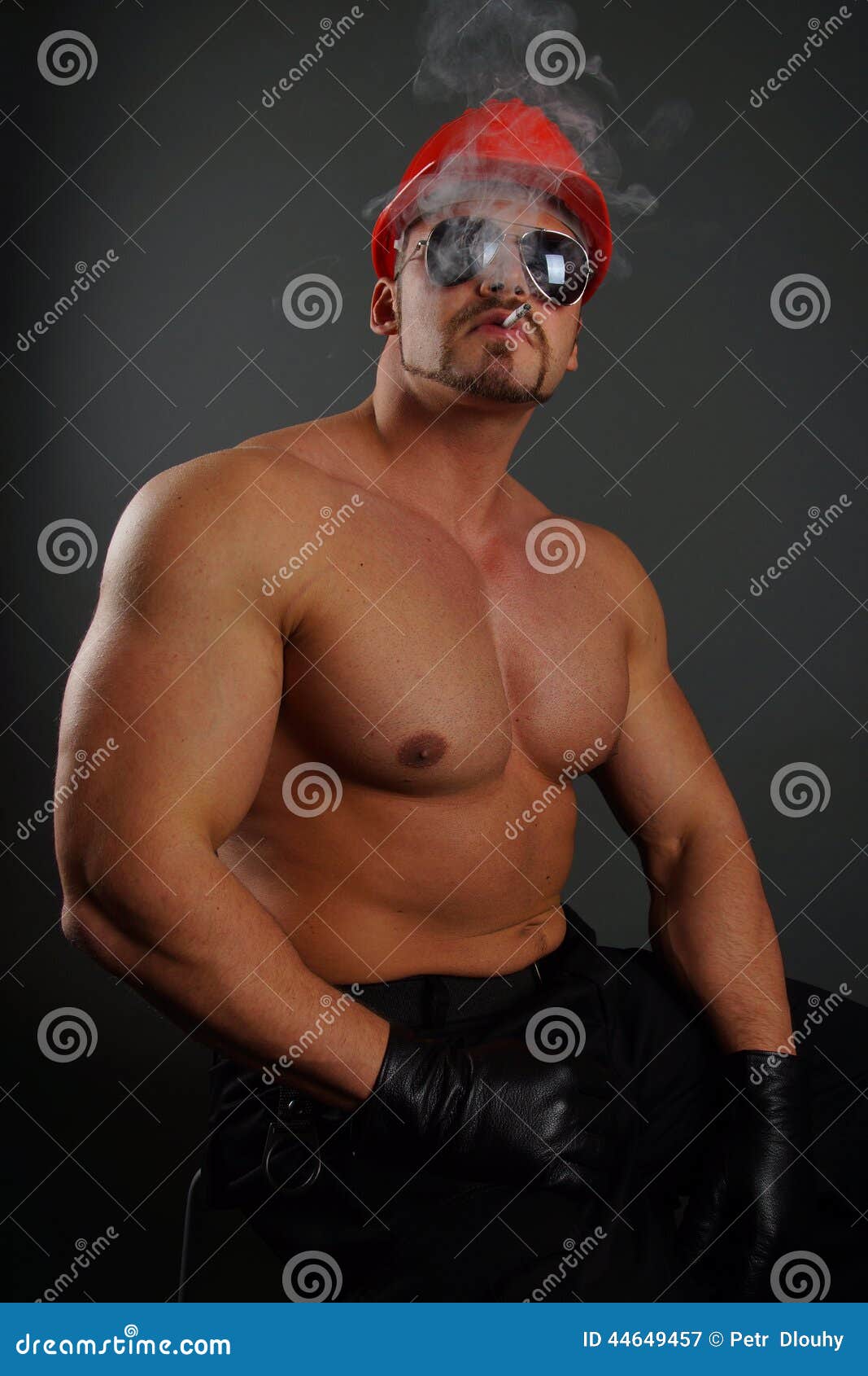 Big muscular worker smoke stock image. Image of business - 44649457