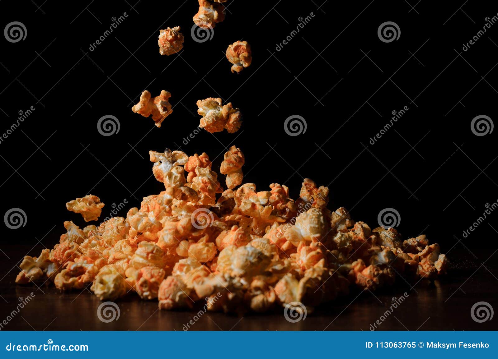Delicious Popcorn Falling Down on the Wooden Table on the Dark ...