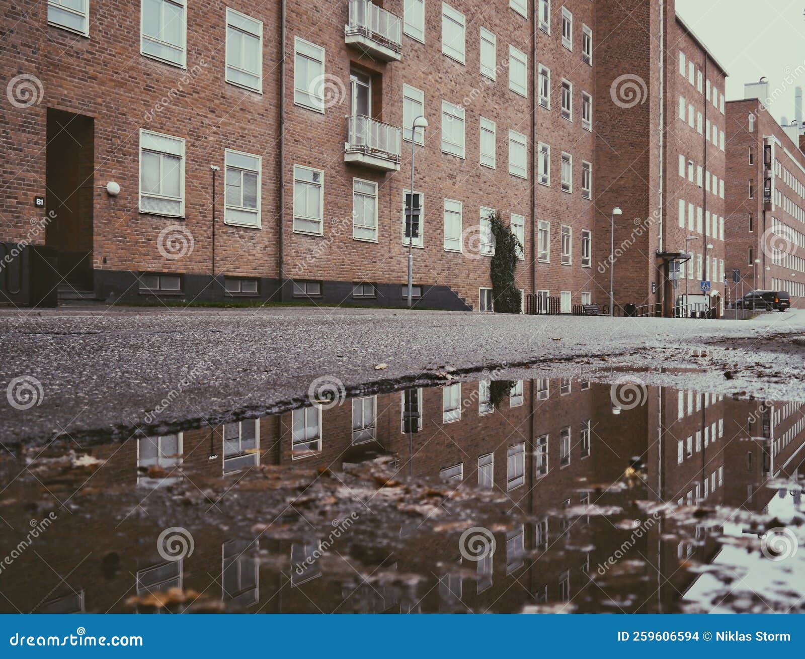 Big Puddle on a Street Next To Buildings Stock Photo - Image of facade ...