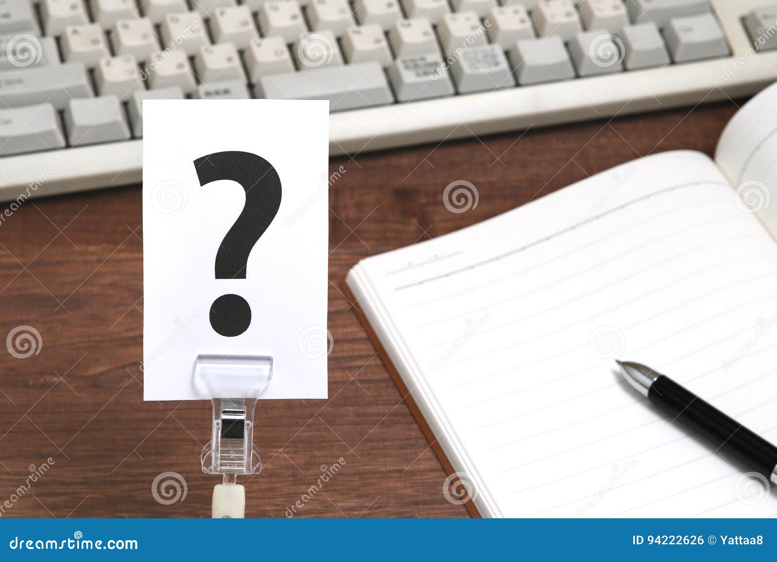 Big Question Mark on a Piece of Paper with Writing Instruments and ...