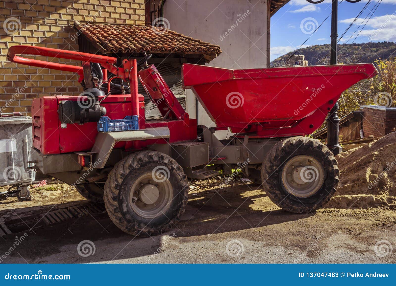 A Big Red Dump Truck in Front of a Building Under Construction. Stock ...