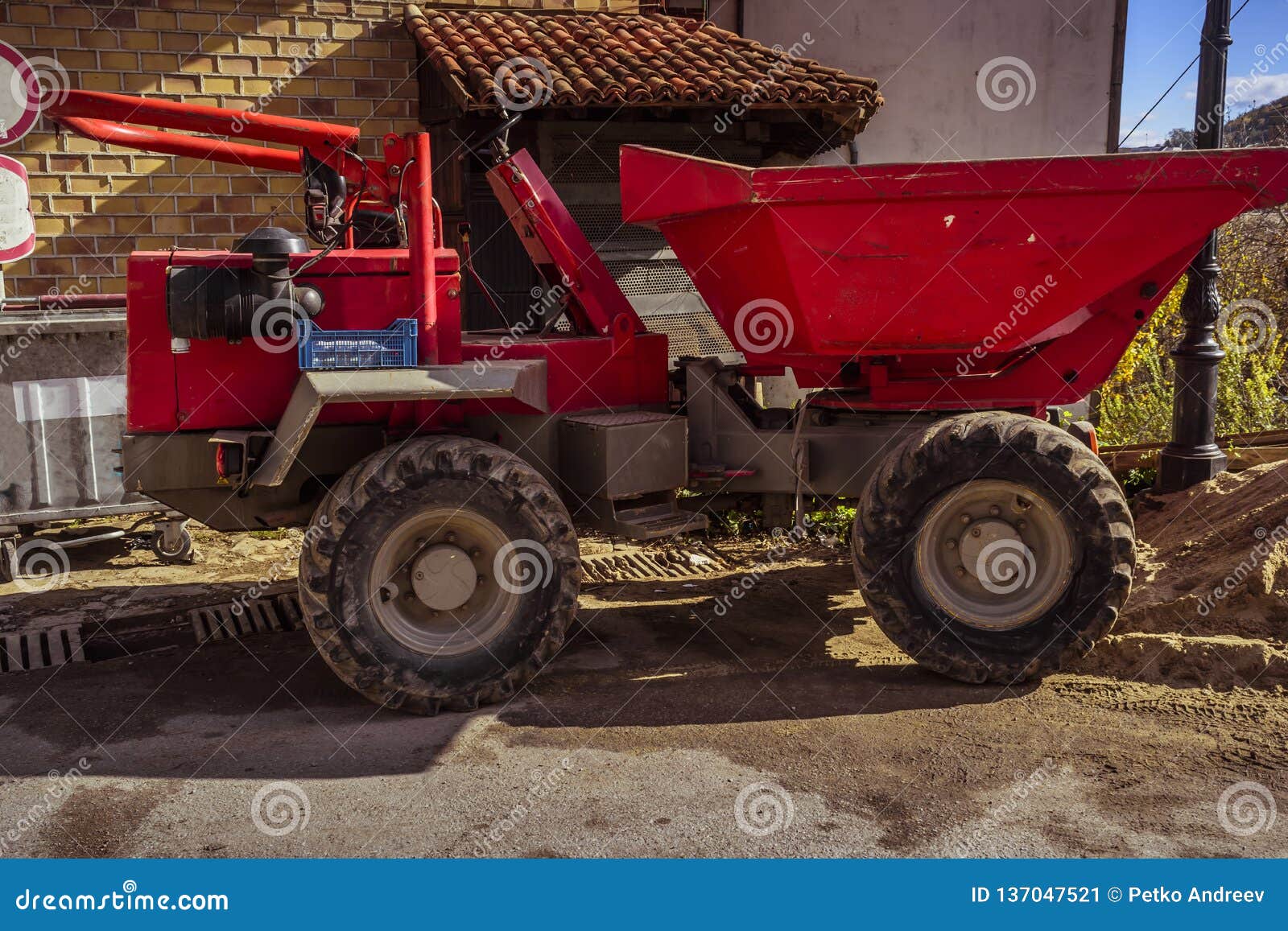 A Big Red Dump Truck in Front of a Building Under Construction. Stock ...