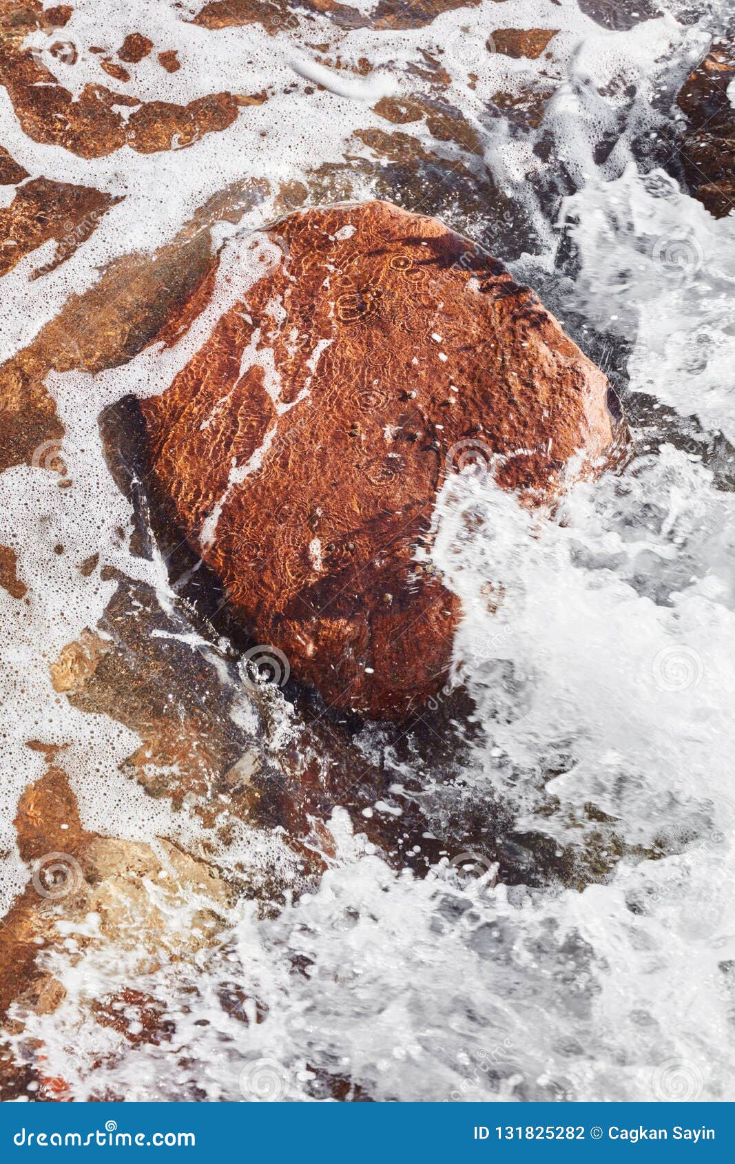 Big red rock in the sea stock photo. Image of backdrop - 131825282