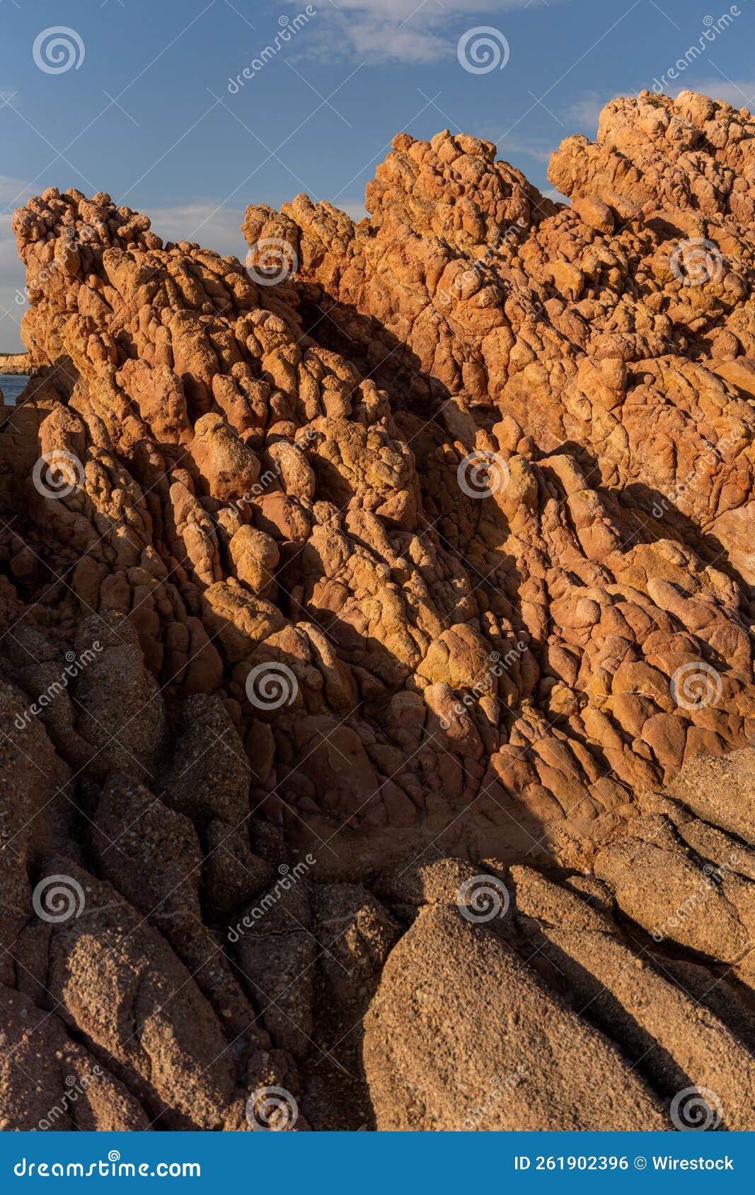 Big red rocks by the beach stock photo. Image of tropical - 261902396