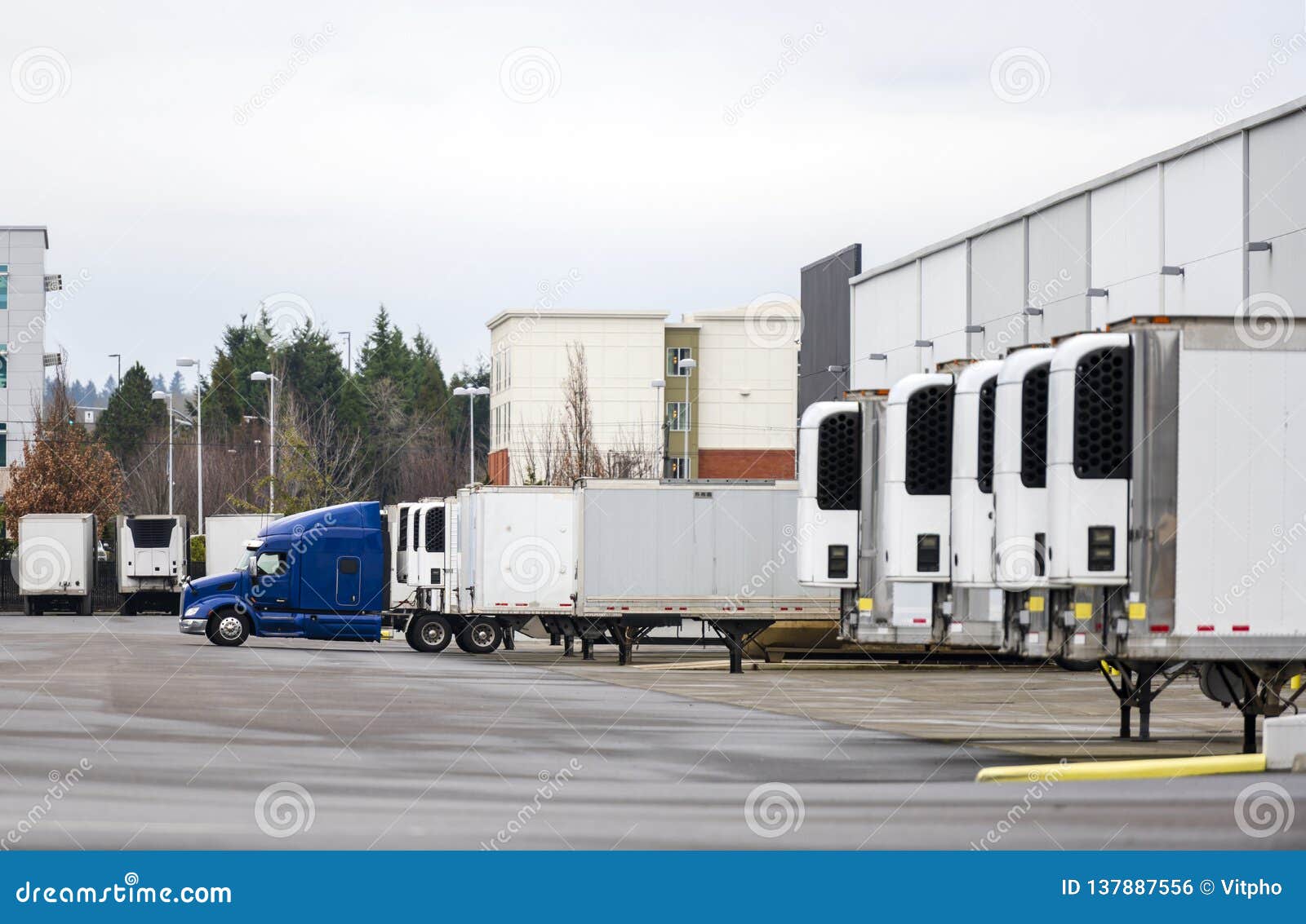 Big Rig Semi Truck and Semi Trailers Standing in Row in Warehouse Dock ...
