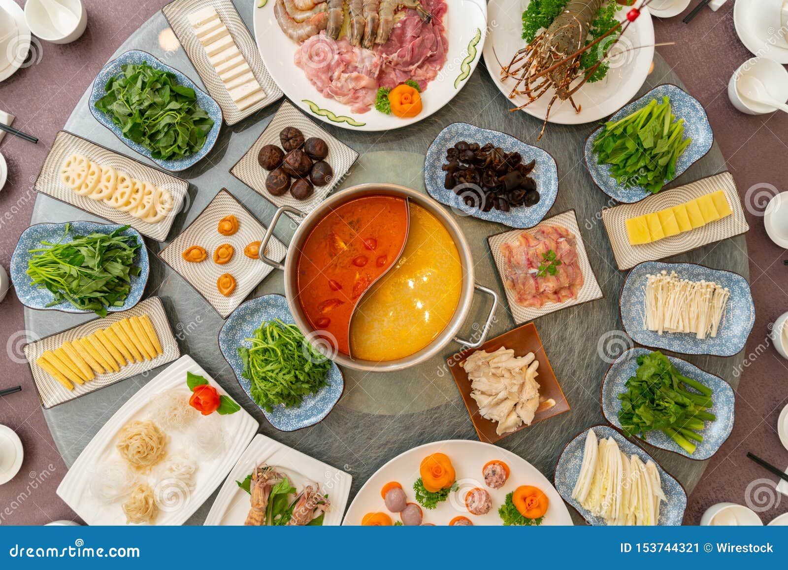 Big Round Table with Different Side Dishes on it with Soup in the ...