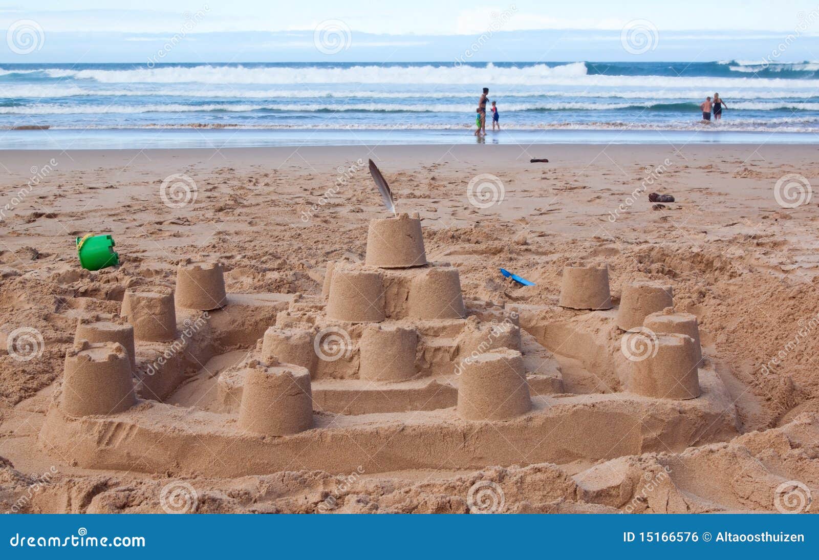 Big Sandcastle on the Beach with People Playing Stock Photo - Image of ...