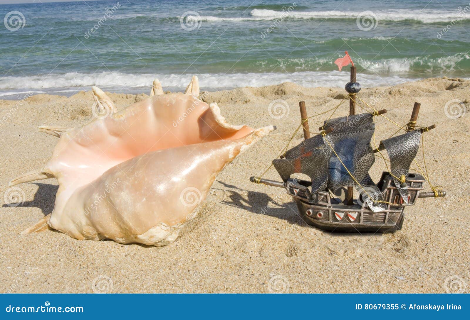 Big Shell and Toy Sailing Ship on Beach Stock Image - Image of yellow ...
