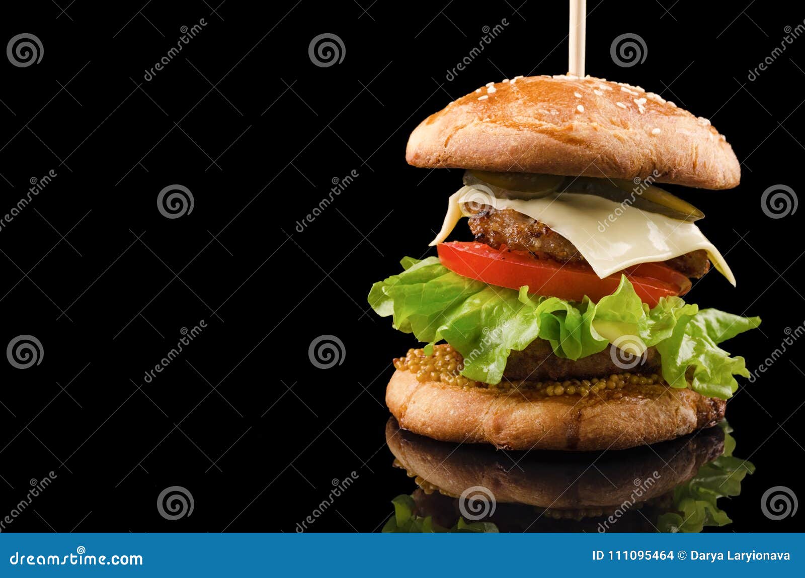 Big Single Cheeseburger Isolated On Black Background Stock Photo ...