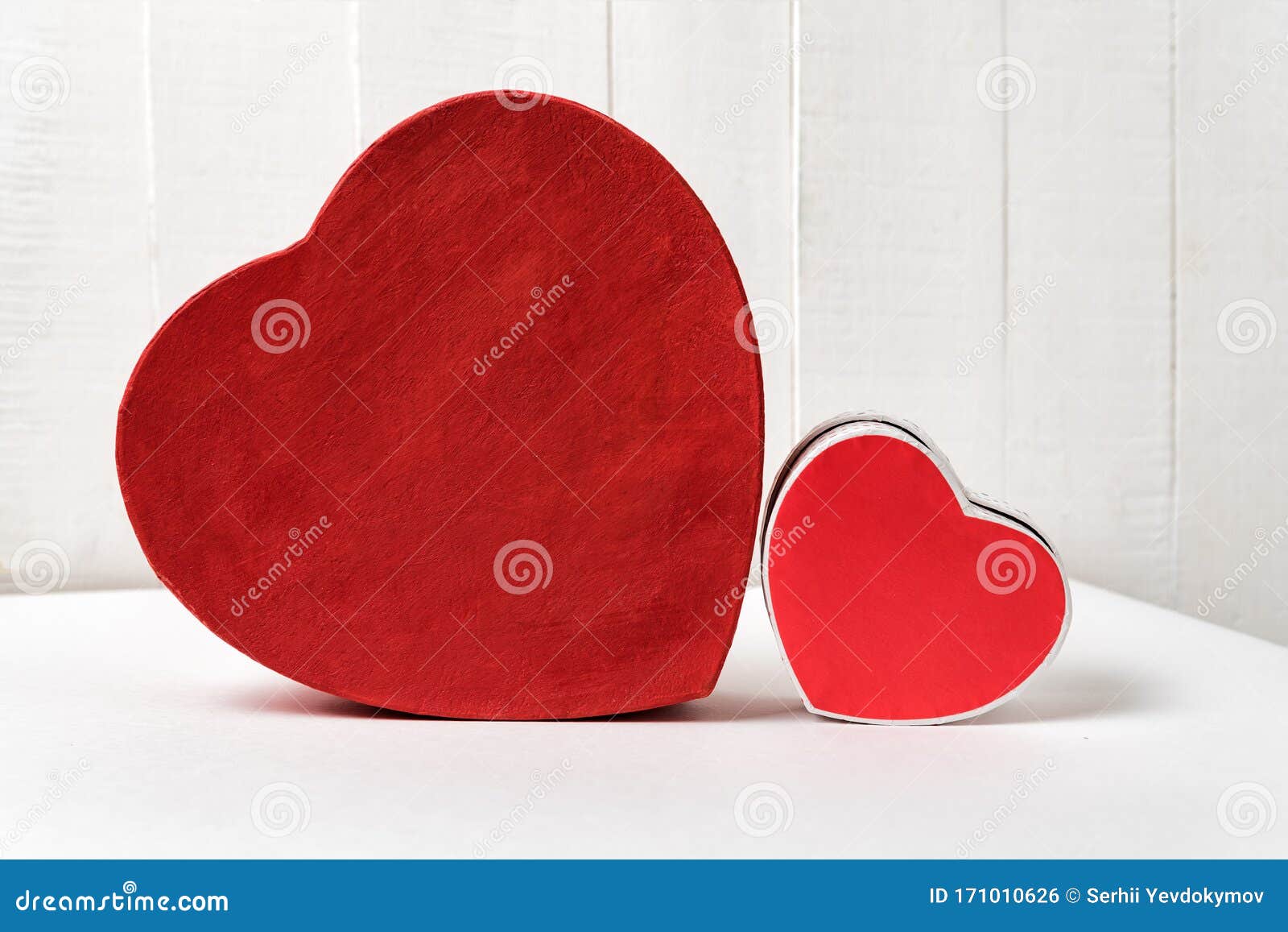 Big and Small Red Heart Shaped Boxes on Table. Side View Stock Photo ...